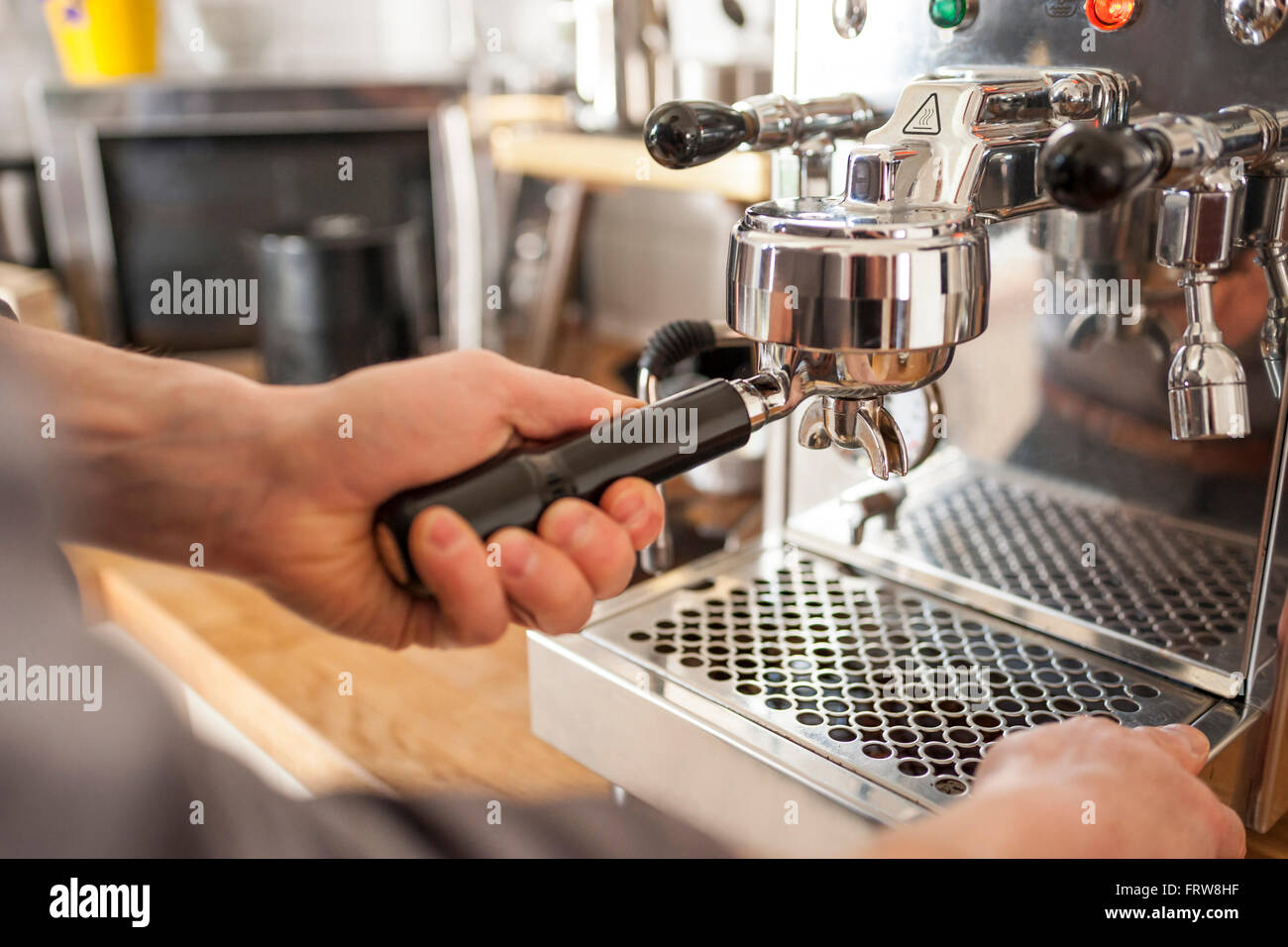 Portafilter inserting in portafilter machine Stock Photo - Alamy