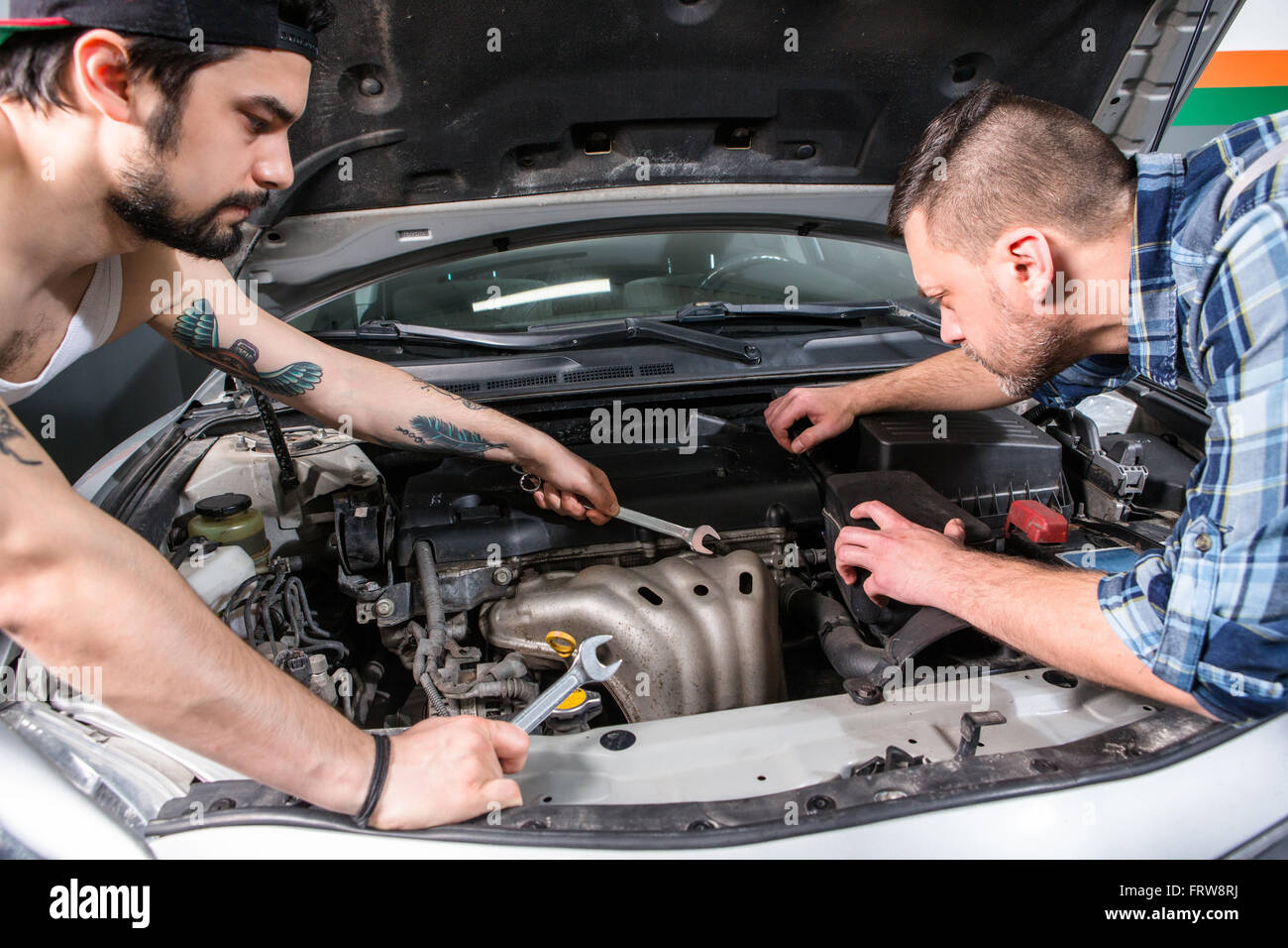 Workers at service station Stock Photo - Alamy