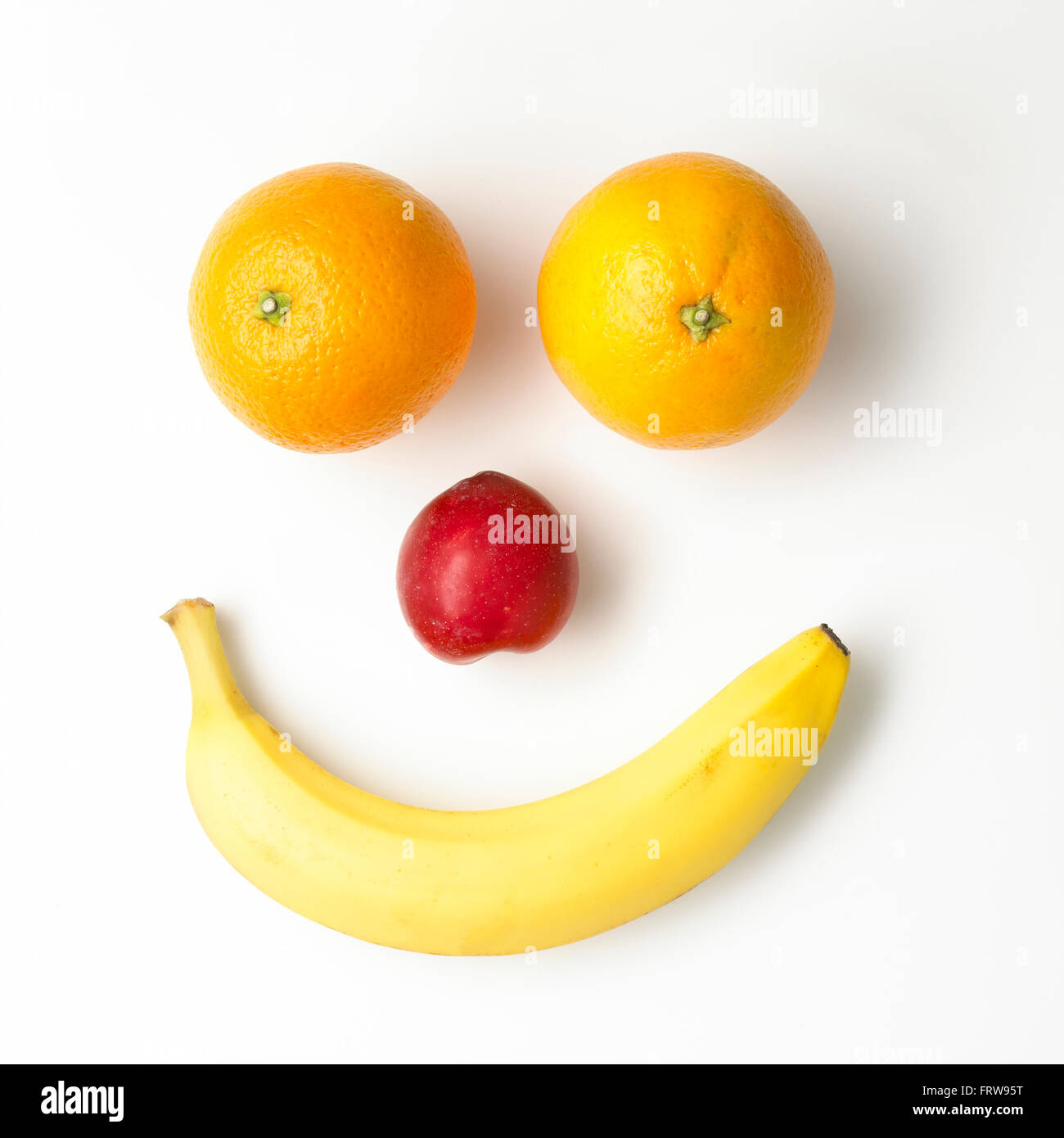 Smiley face built of fruits on white ground Stock Photo - Alamy