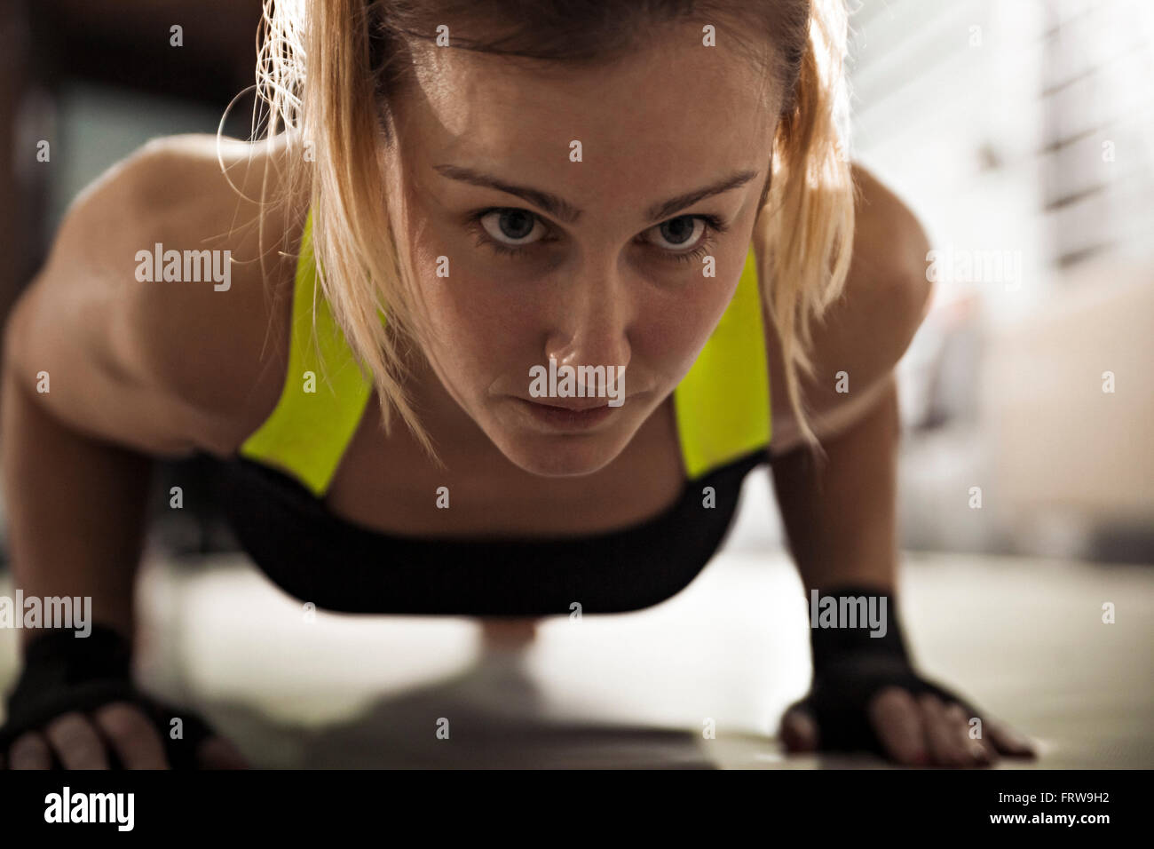 Woman doing push-ups in gym Stock Photo - Alamy
