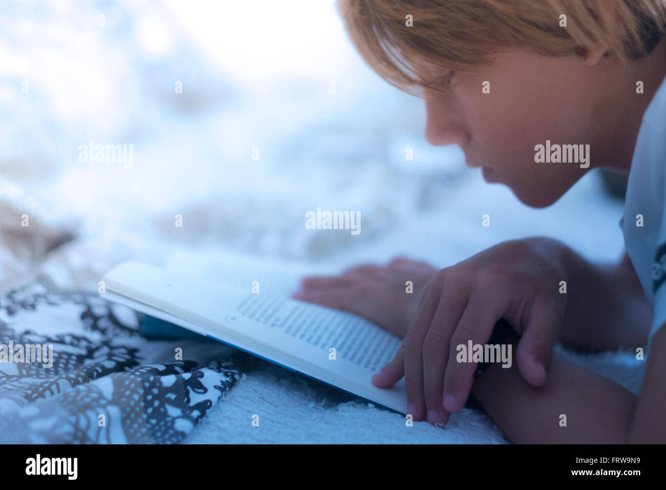 Boy reading a book Stock Photo - Alamy