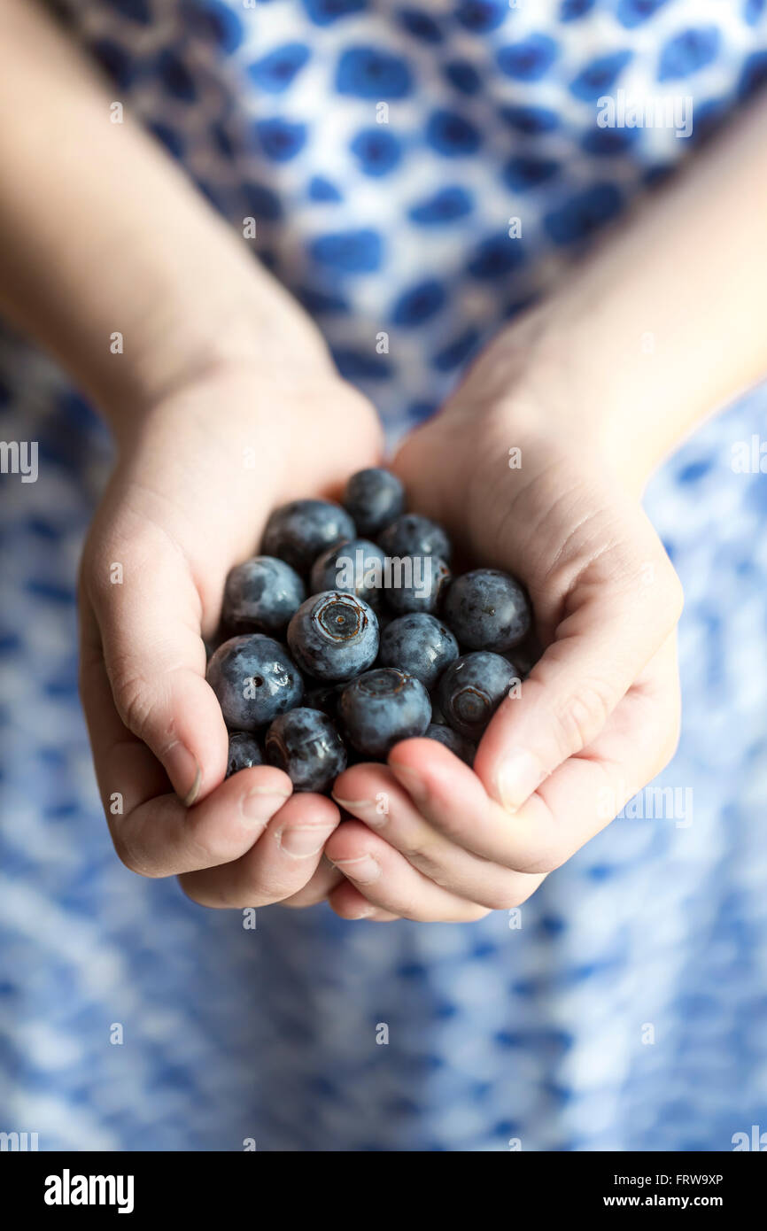 Hands of girl holding blueberries Stock Photo - Alamy