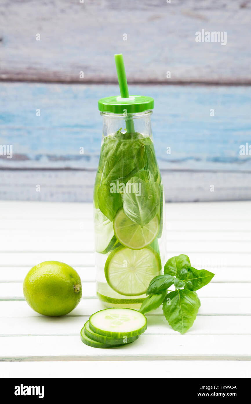 Glass bottle of infused water with lime, cucumber and basil Stock Photo ...