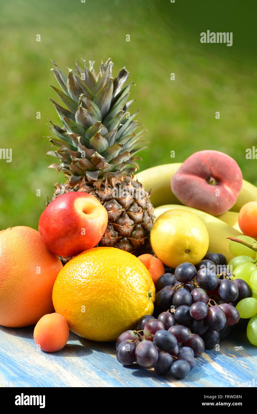 variety of fruits on table in the garden Stock Photo - Alamy