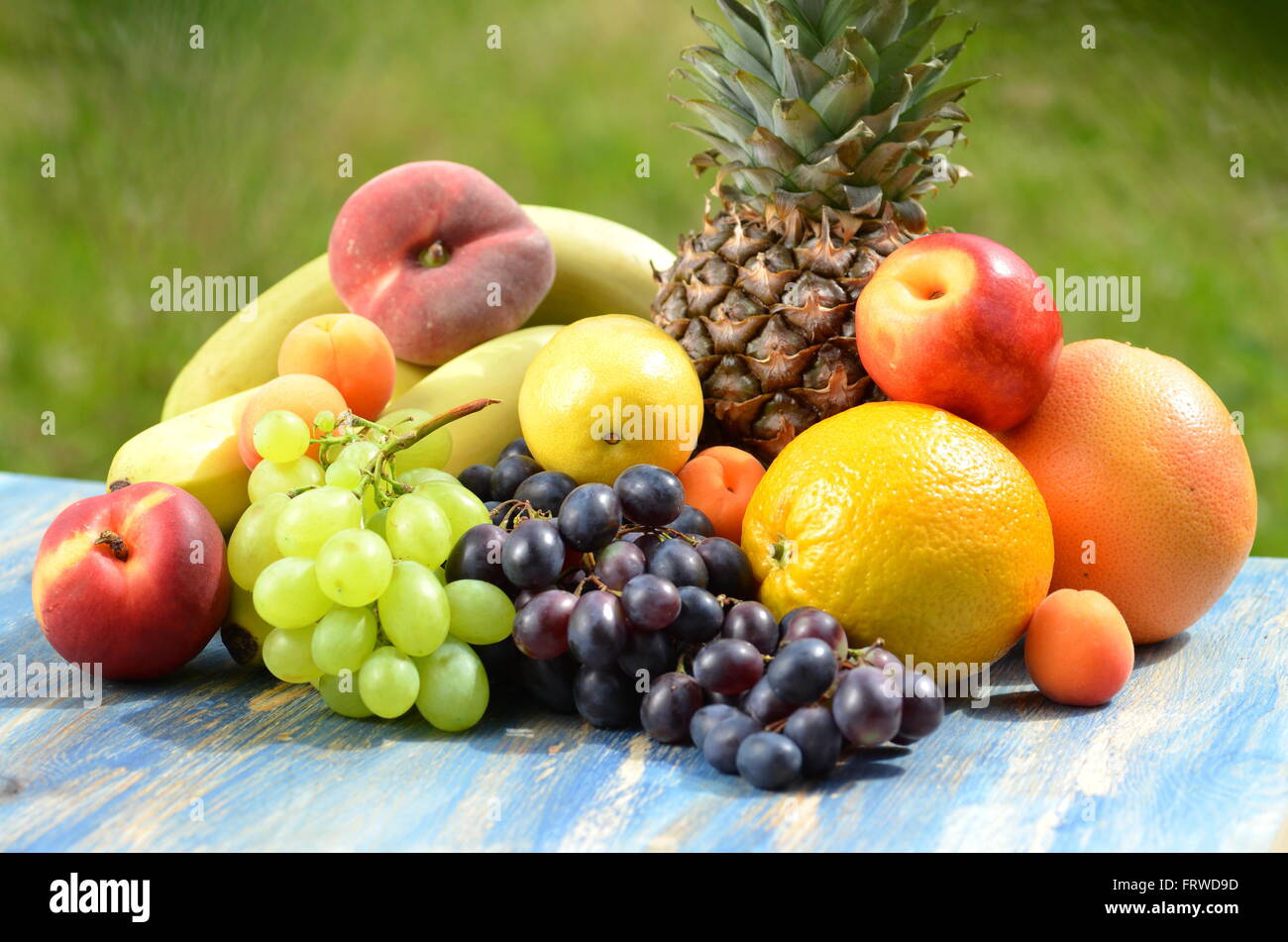 variety of fruits on table in the garden Stock Photo - Alamy