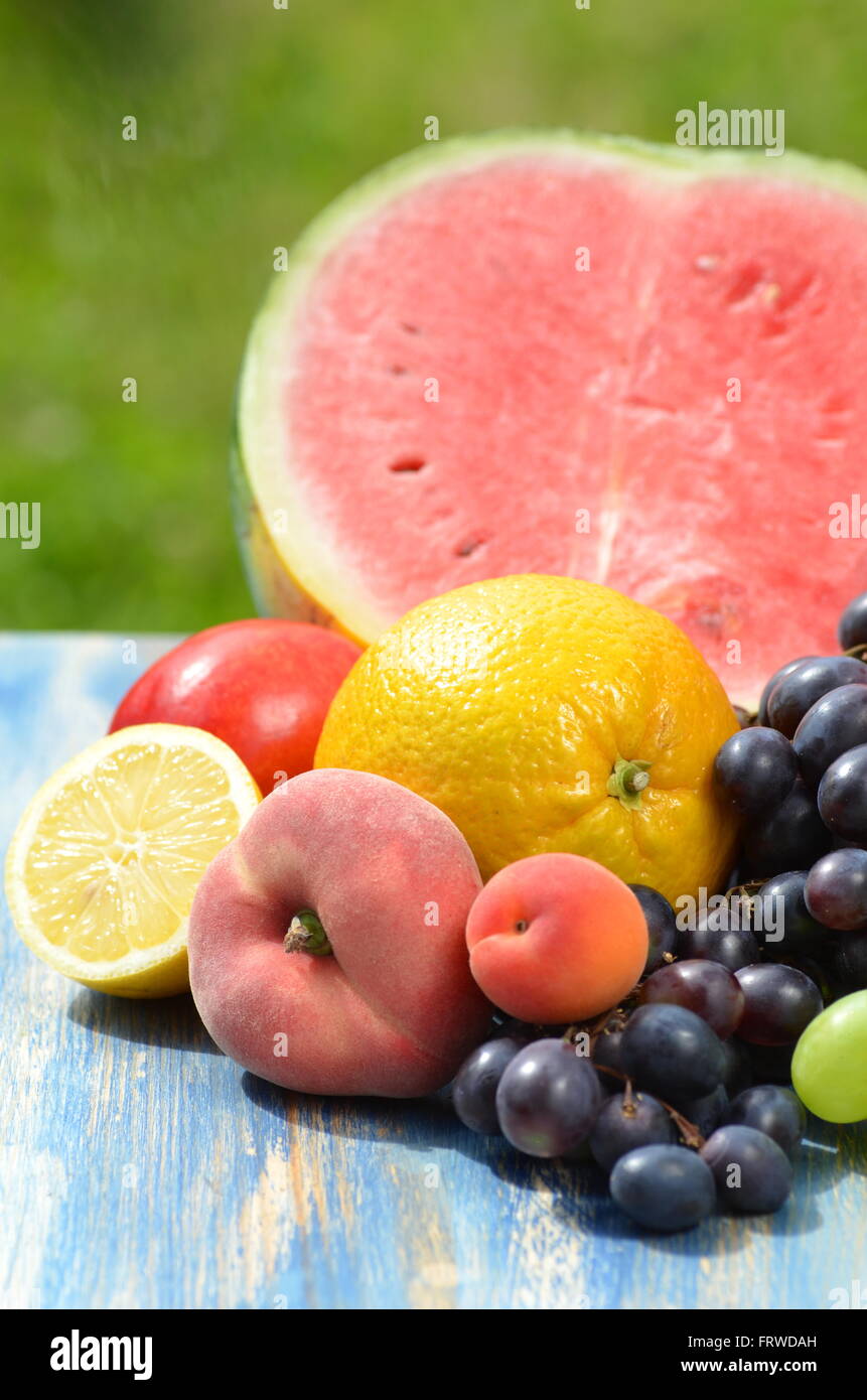 variety of fruits on table in the garden Stock Photo - Alamy