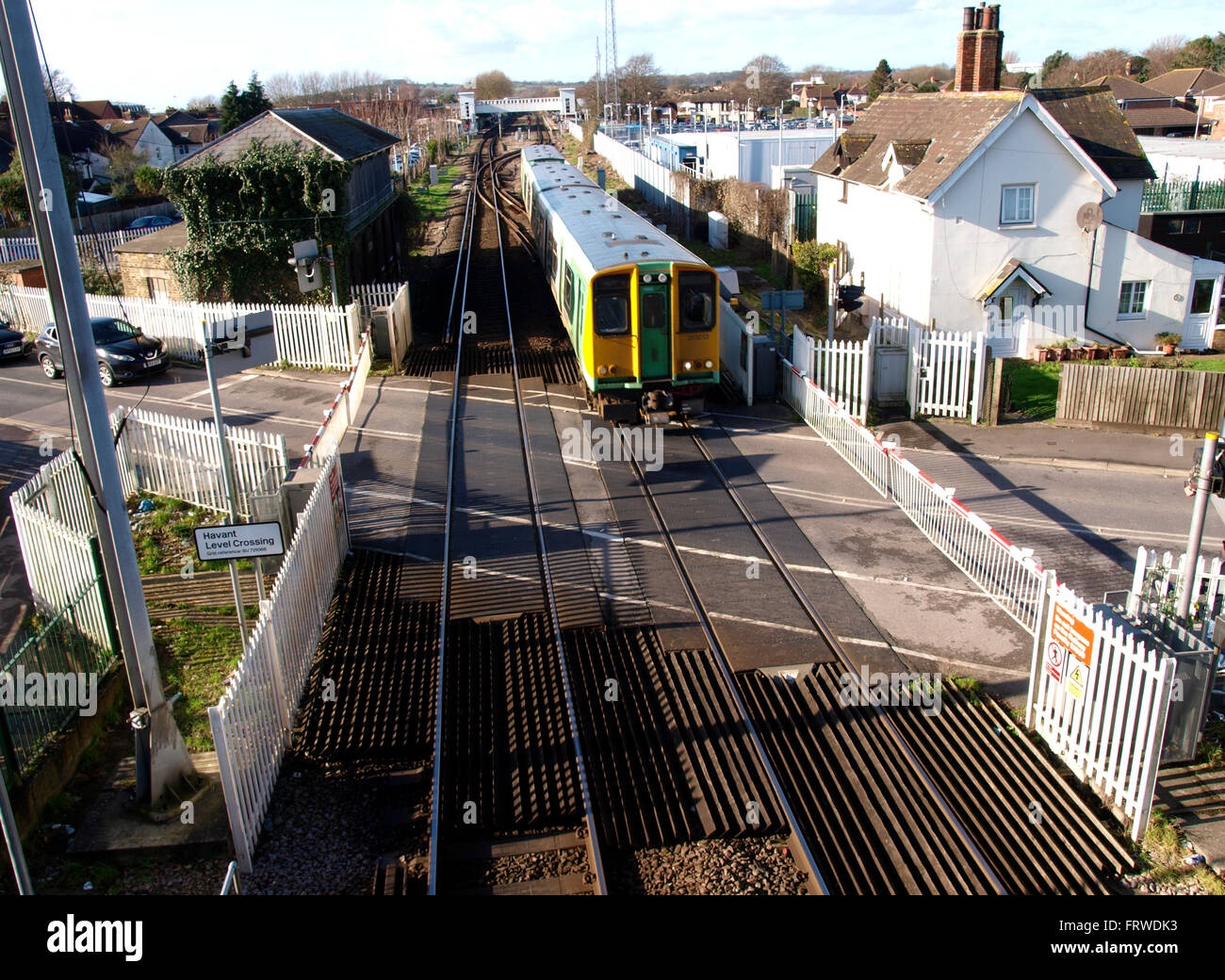 Train crossing Havant Level Crossing, Hampshire, UK Stock Photo - Alamy
