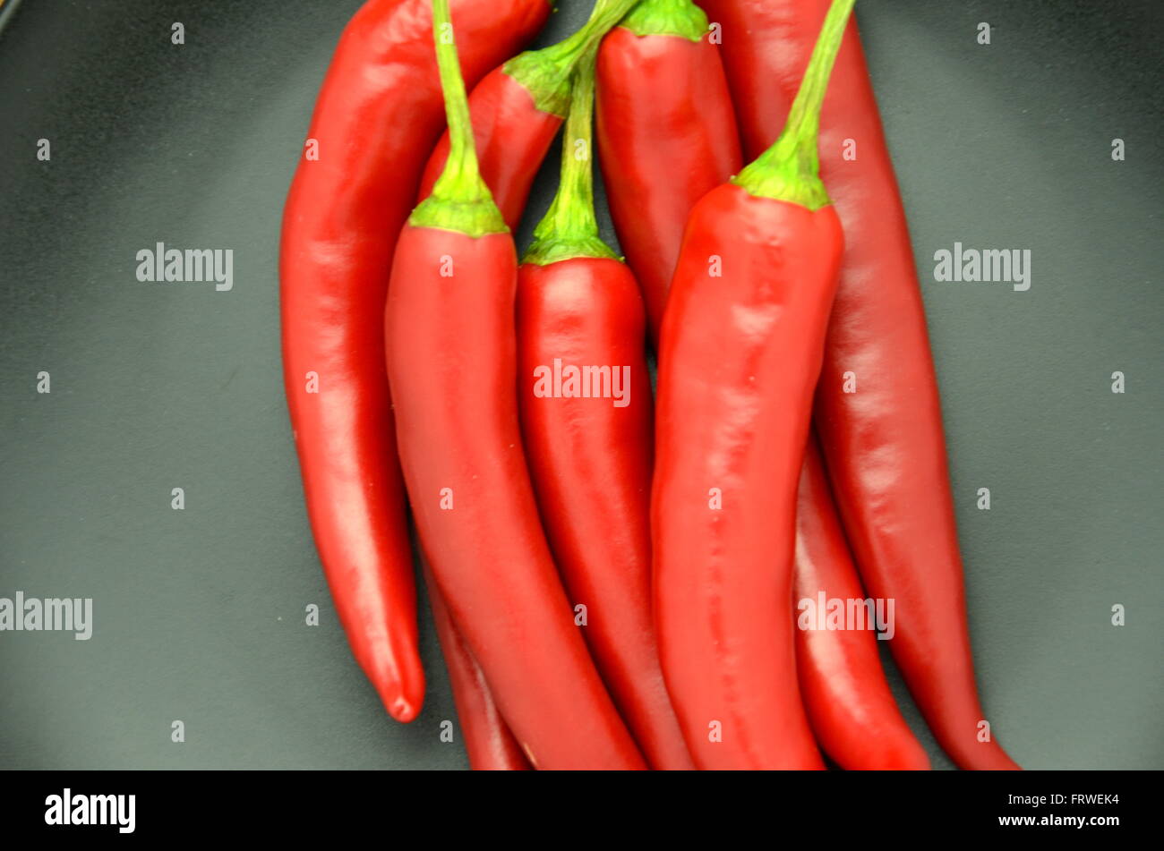 red hot chilli peppers on table Stock Photo - Alamy
