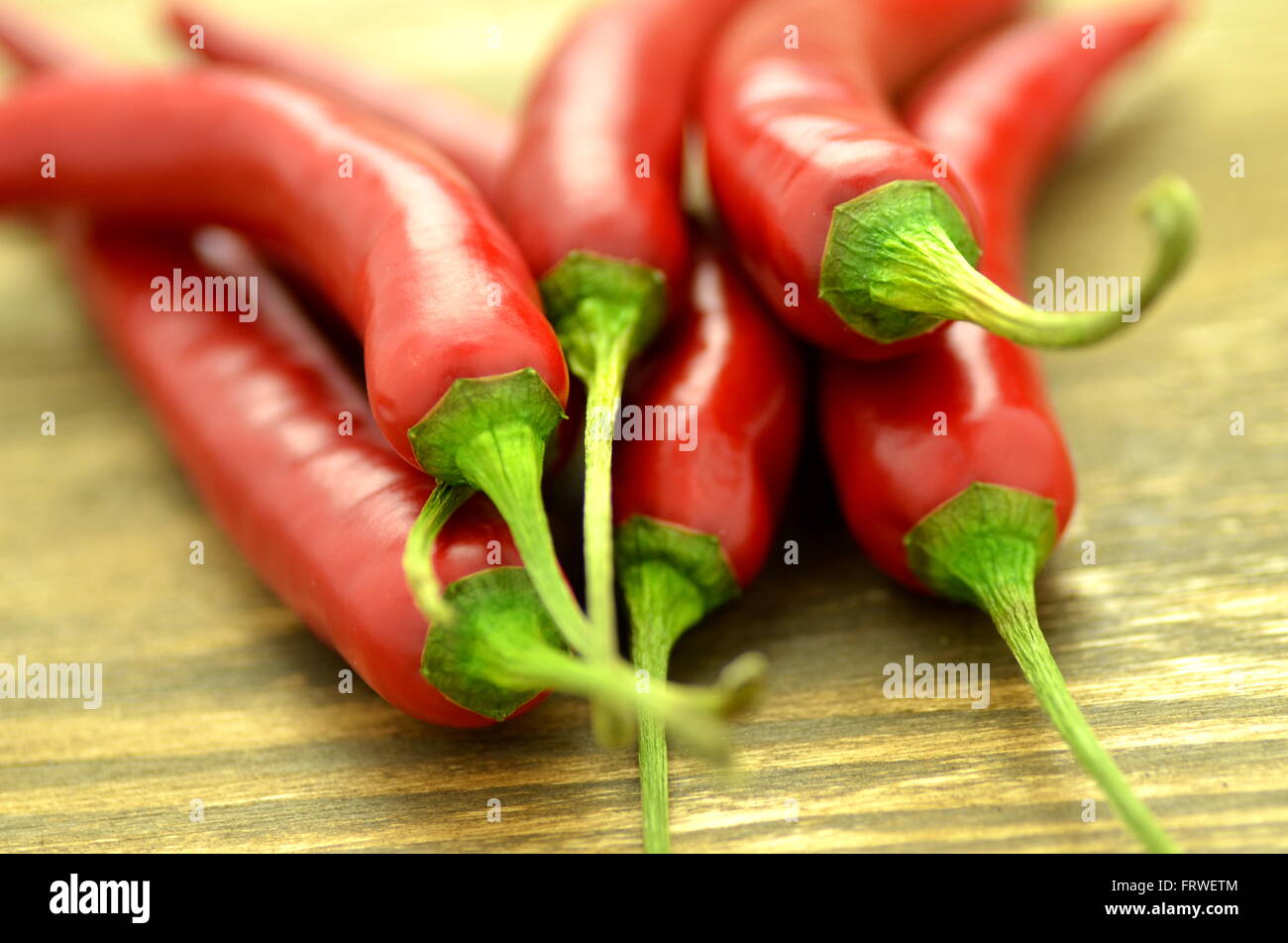 red hot chilli peppers on table Stock Photo - Alamy
