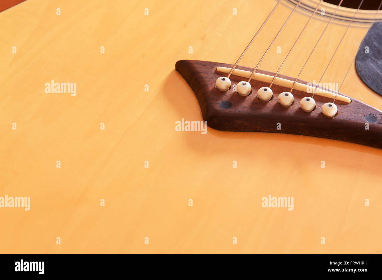 bridge acoustic guitars. six strings for background Stock Photo - Alamy