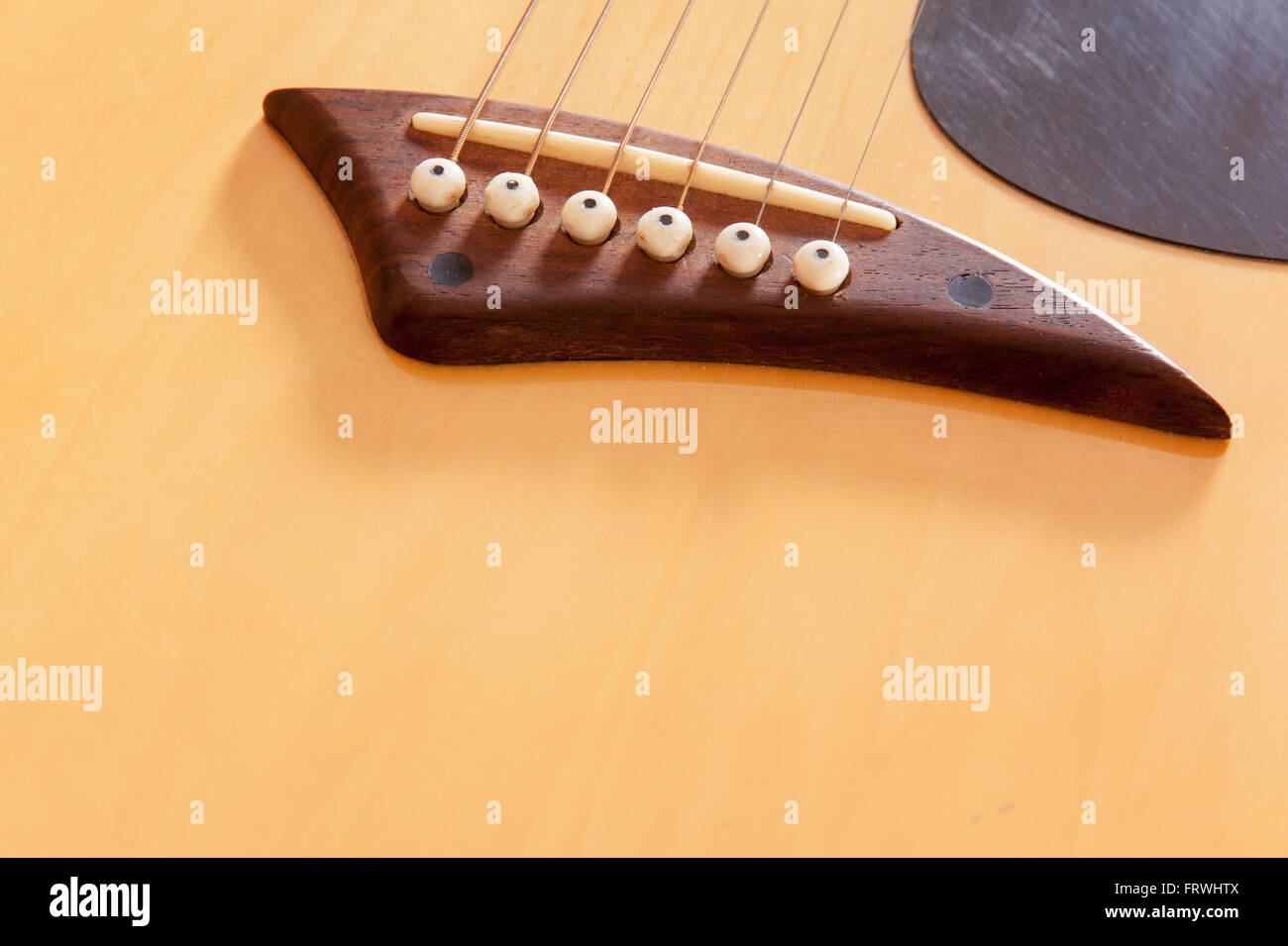 bridge acoustic guitars. six strings for background Stock Photo - Alamy