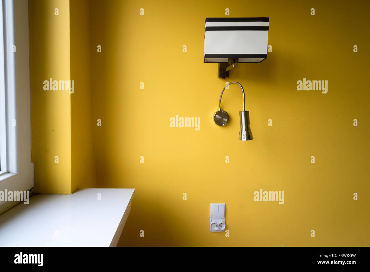 yellow interior room with windowsill and simple wall light Stock Photo ...