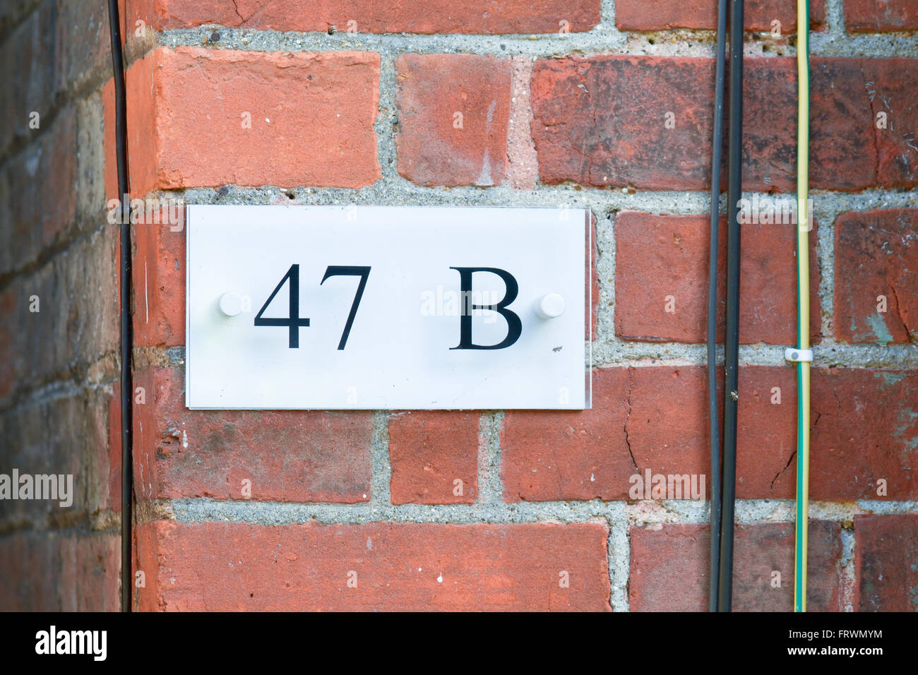House Number 47B sign on wall Stock Photo - Alamy