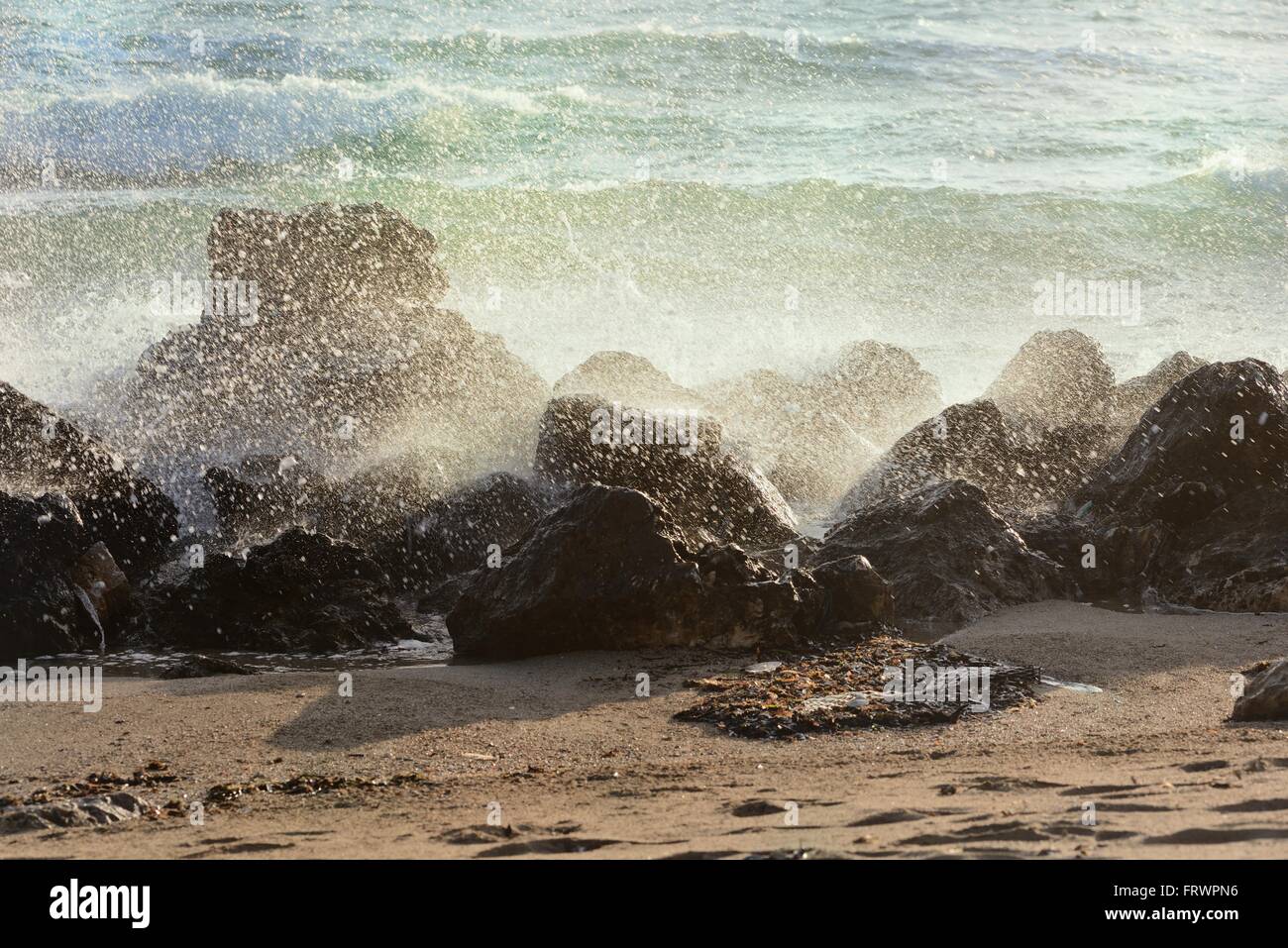 Sand, rocks and splashes Stock Photo - Alamy