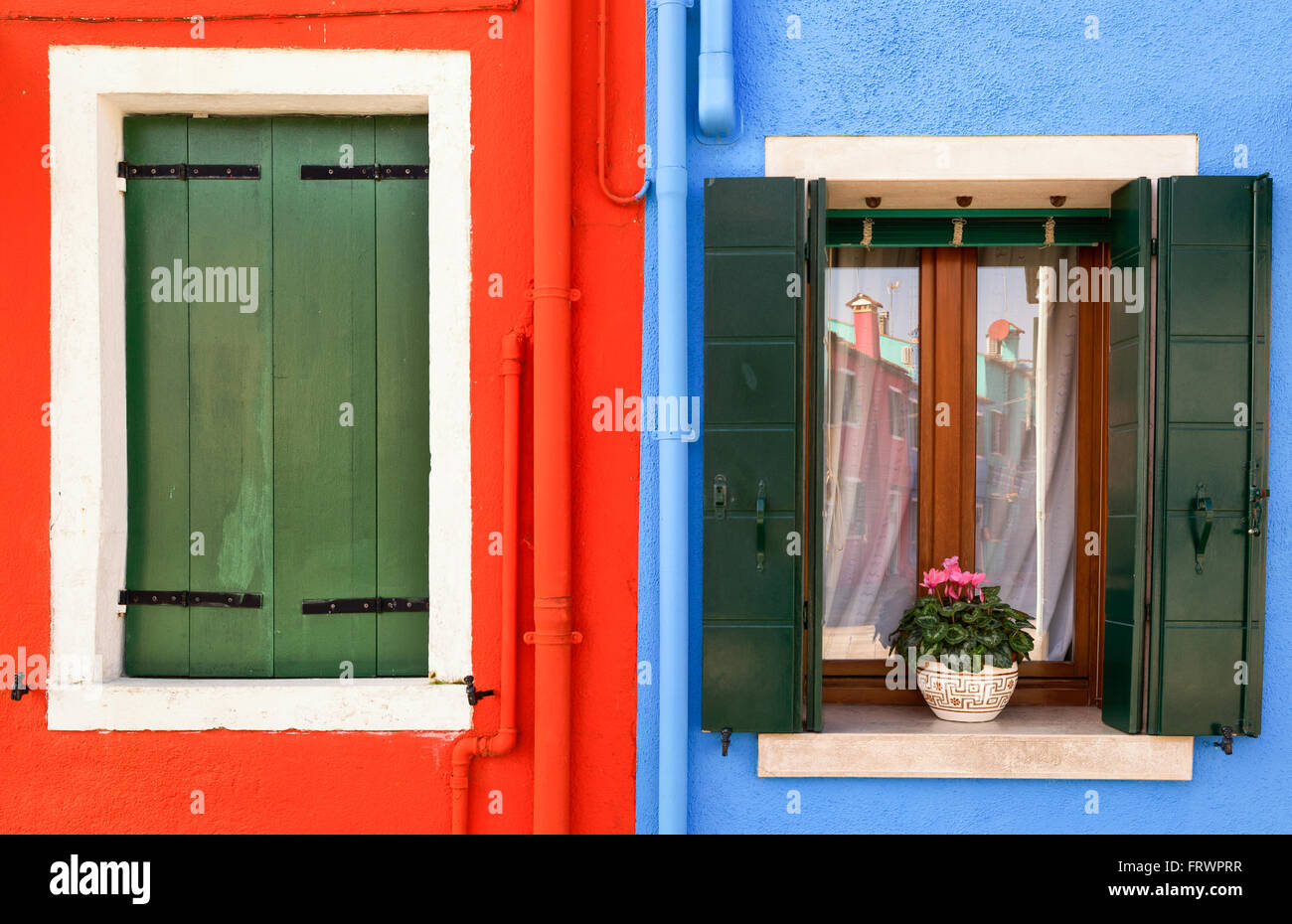 One close and one open window shutters with typical reflection of ...