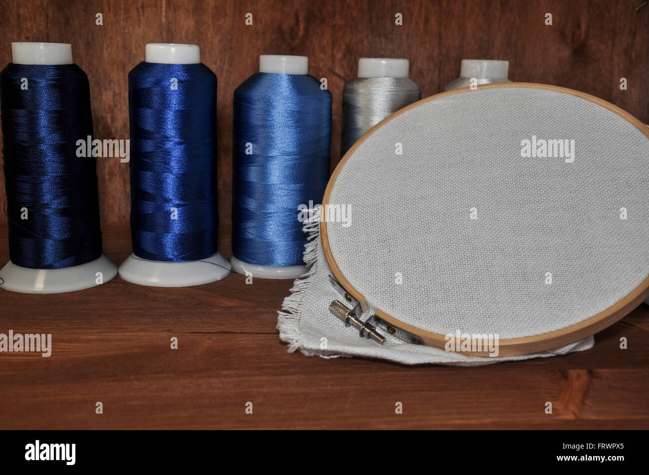 Set for embroidery of colorful threads, hoops, thimble and needle on ...