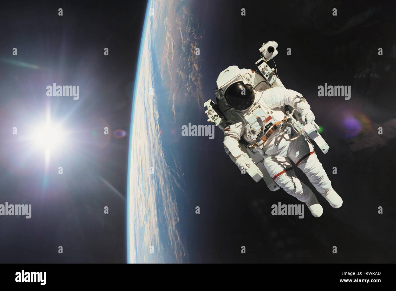 Astronaut in outer space with planet earth as backdrop. Elements of ...