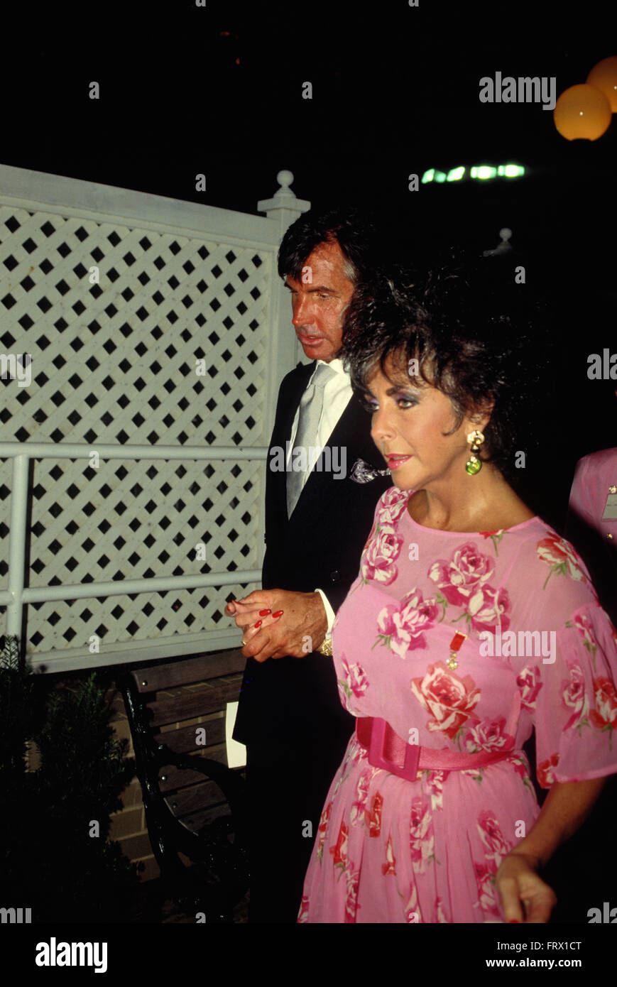 Washington, DC., USA, 2nd June, 1987 Elizabeth Taylor is escorted by ...