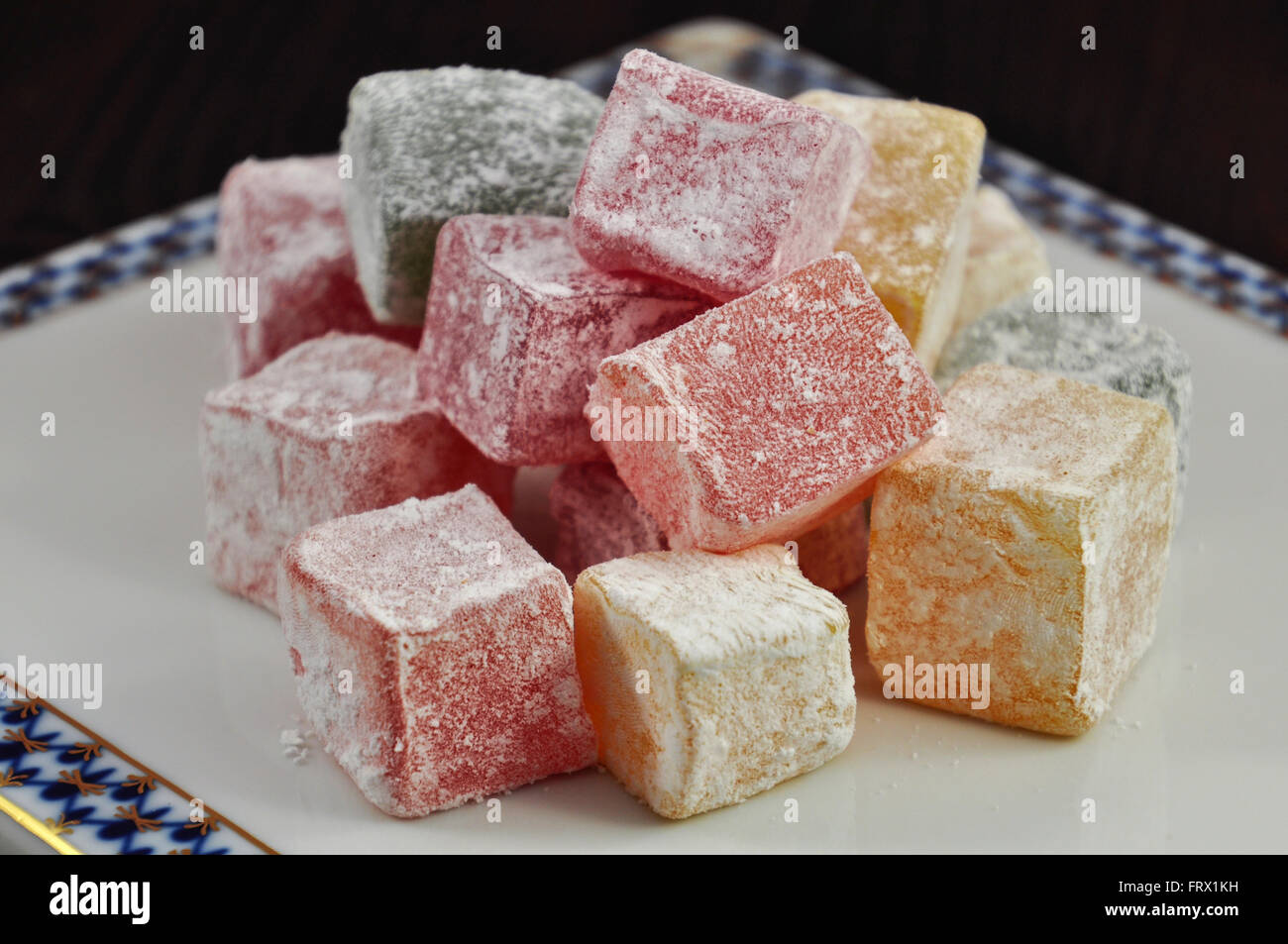 Square colorful Turkish sweets in powdered sugar Stock Photo - Alamy