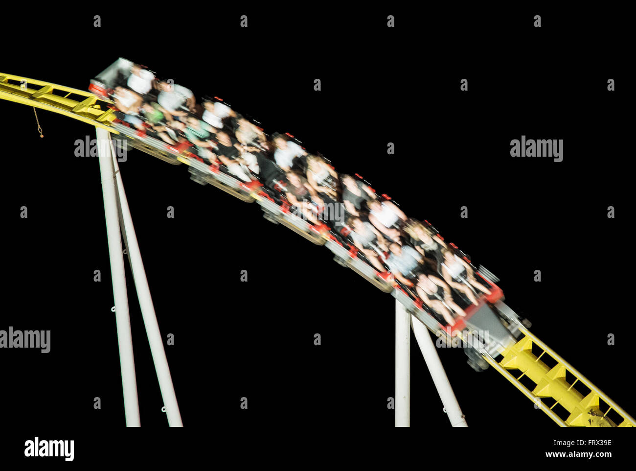 Roller coaster ride in amusement park in the night. Free time ...
