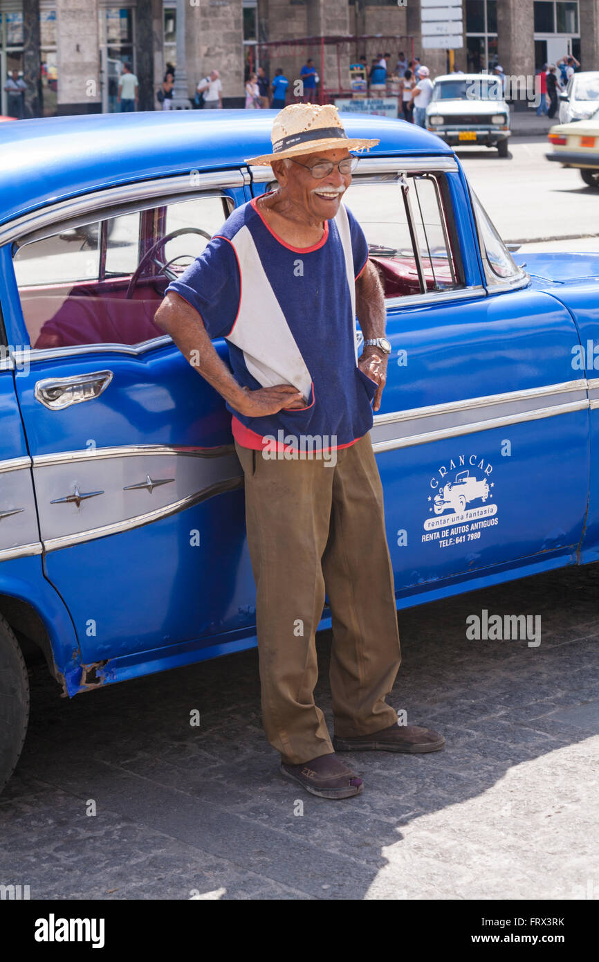 Daily life in Cuba - taxi driver standing smiling outside taxi at ...