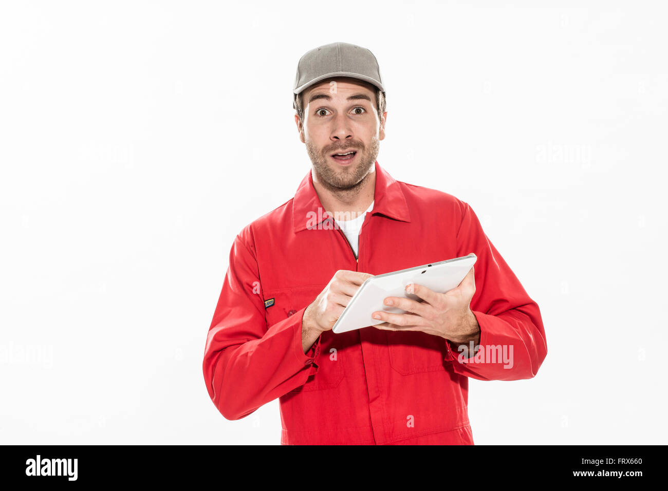 closeup portrait of a workman with expressive face using digital tablet ...