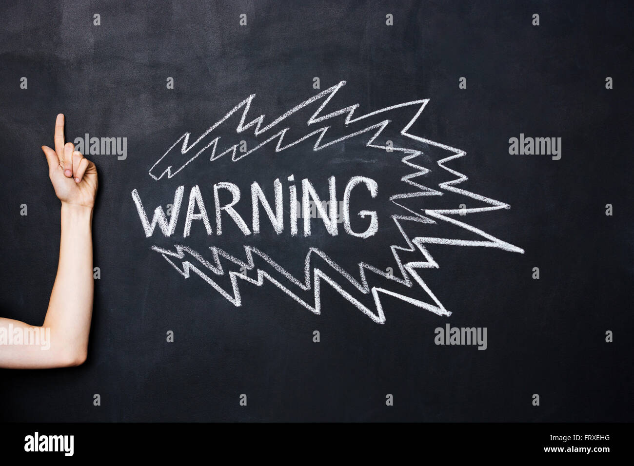 Hand pointing up near warning drawn on blackboard by chalk Stock Photo ...