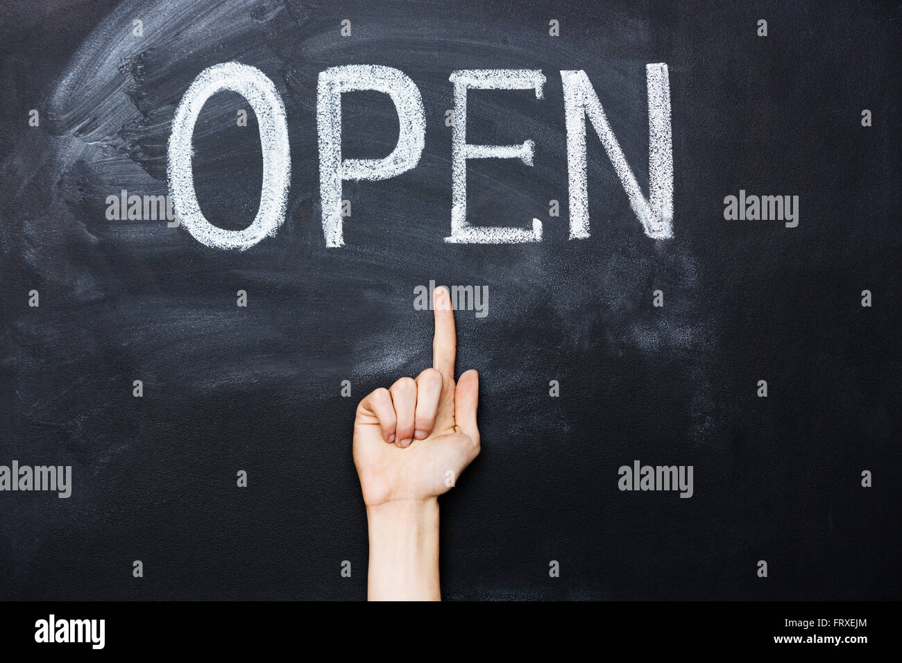 Hand pointing on open sign drawn on blackboard by chalk Stock Photo - Alamy