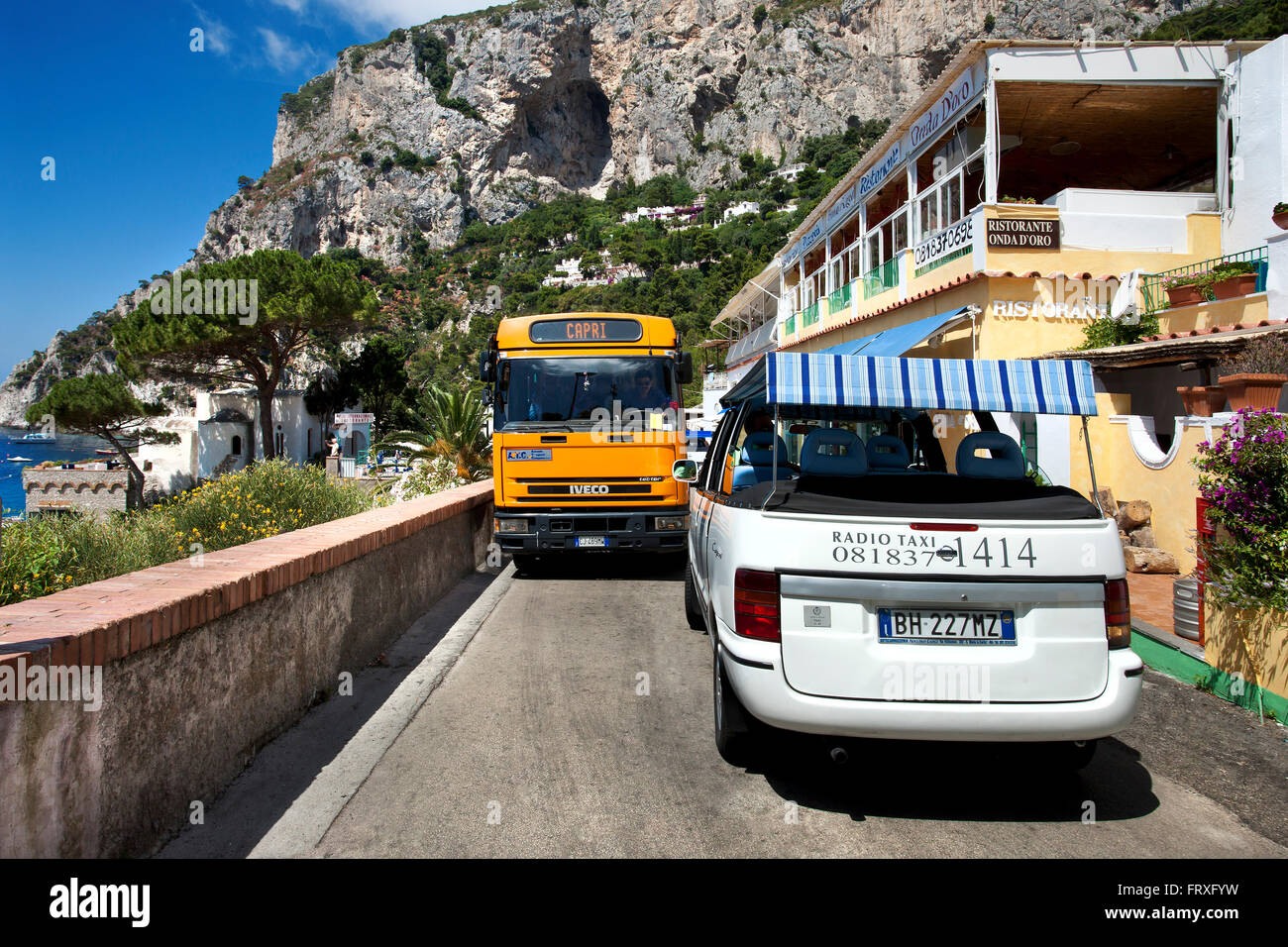 Bus and Taxi on a narrow road, Capri, Bay of Naples, Campania, Italy ...