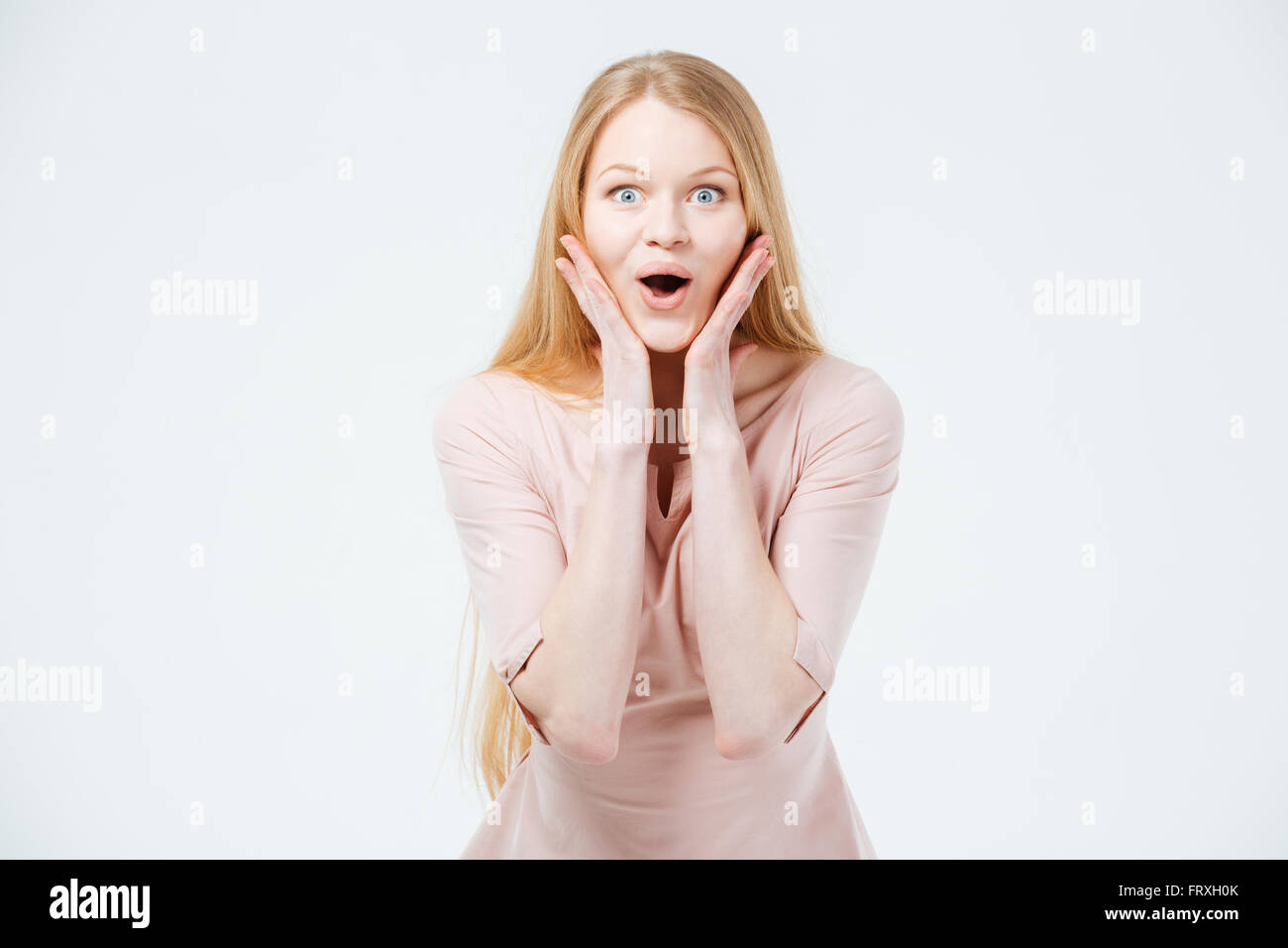 Amazed woman standing isolated on a white background Stock Photo - Alamy