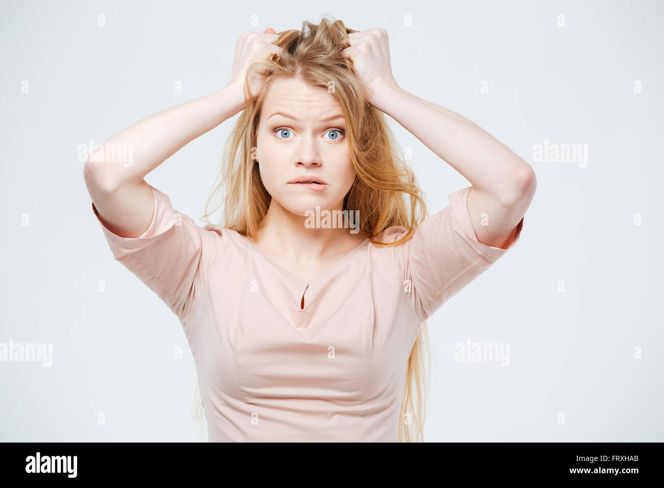 Stressed woman standing isolated on a white background Stock Photo - Alamy