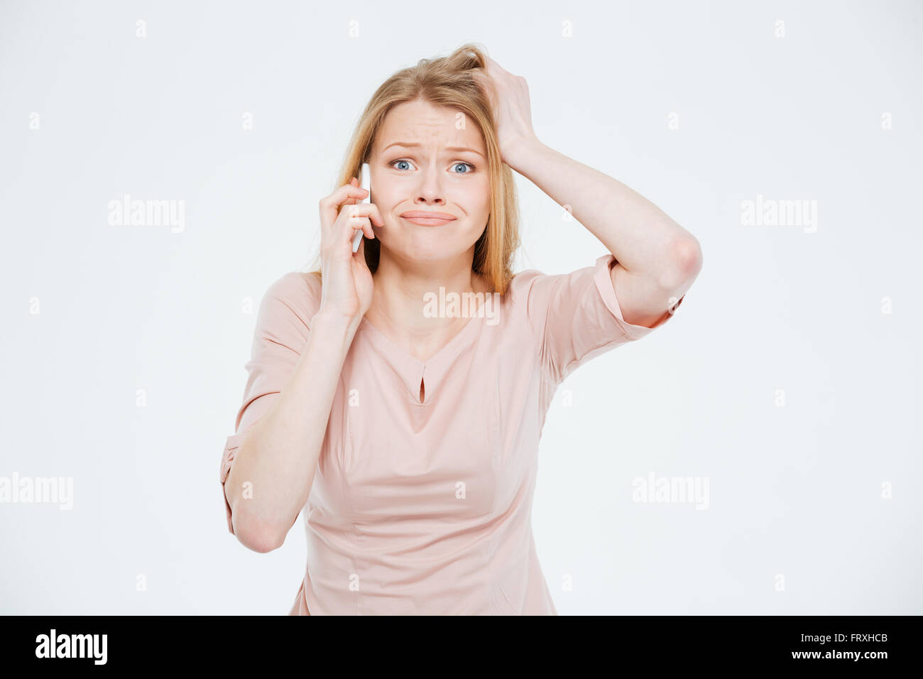 Sad woman talking on the phone isolated on a white background Stock ...