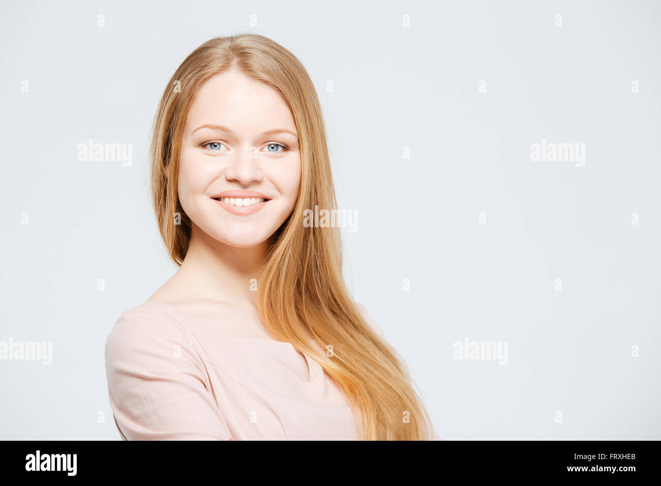 Smiling woman standing isolated on a white background Stock Photo - Alamy