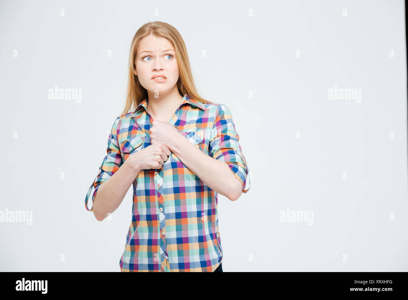 Scared woman standing isolated on a white background Stock Photo - Alamy
