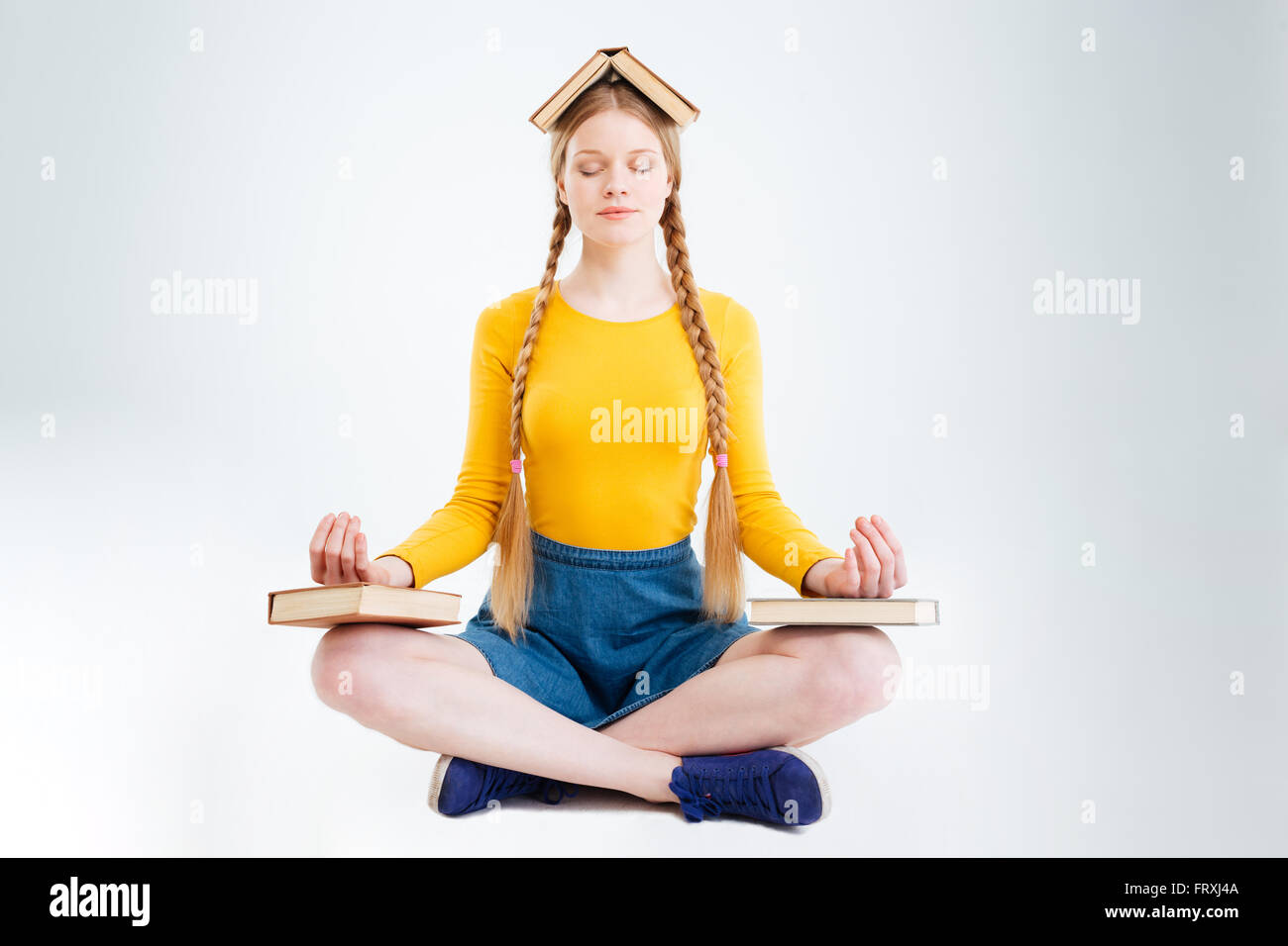 Female student meditating isolated on a white background Stock Photo ...
