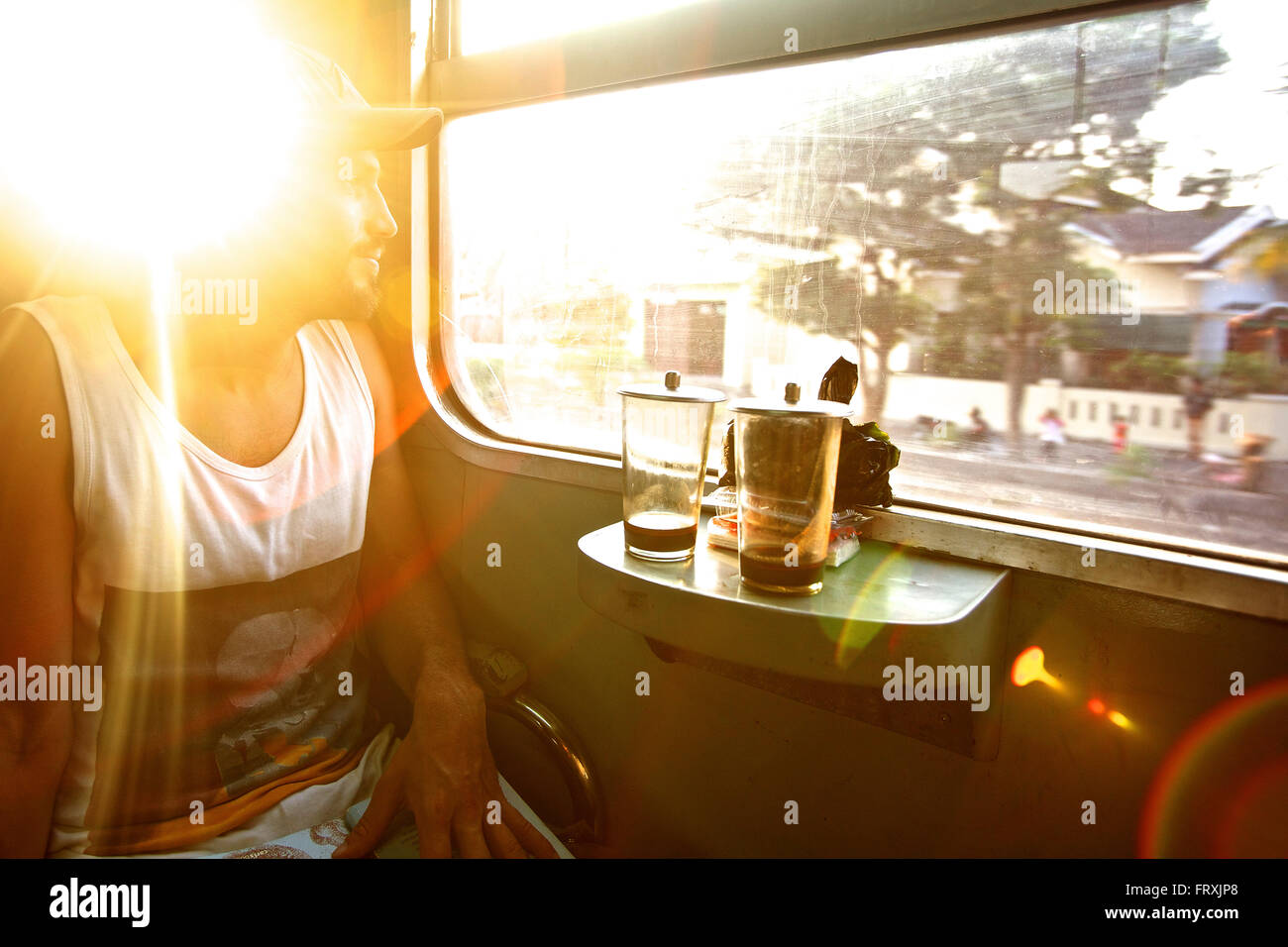 Man looking out of a train window, Jakarta, Java, Indonesia Stock Photo ...