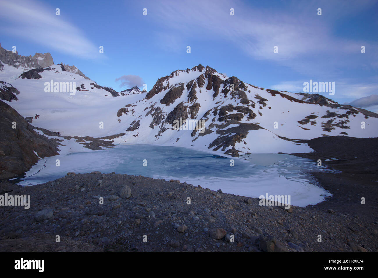Frozen Laguna de Los Tres, mountain lake below Fitz Roy, morning light ...