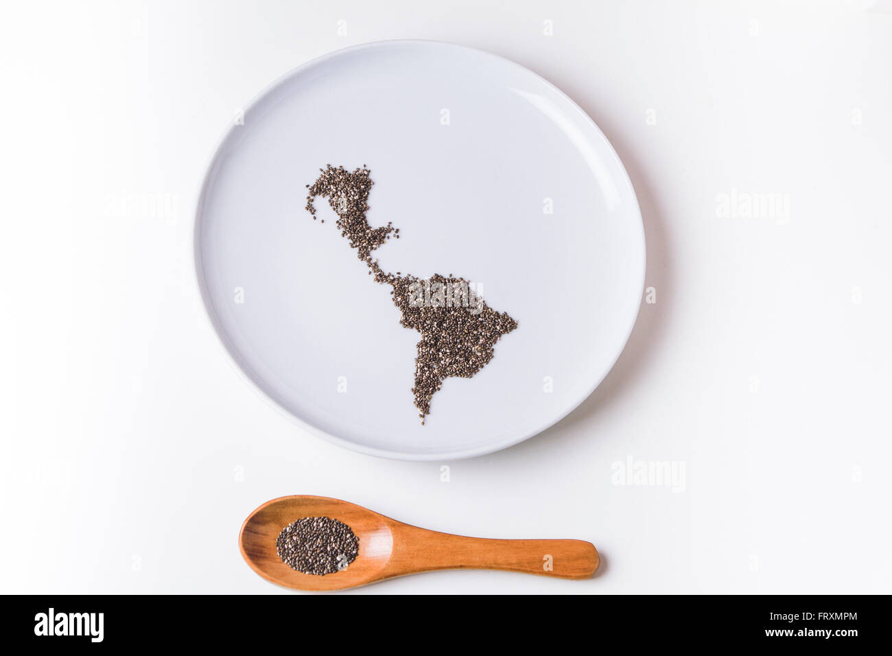 Chia seeds on plate shaped like a map of latin america with wooden ...