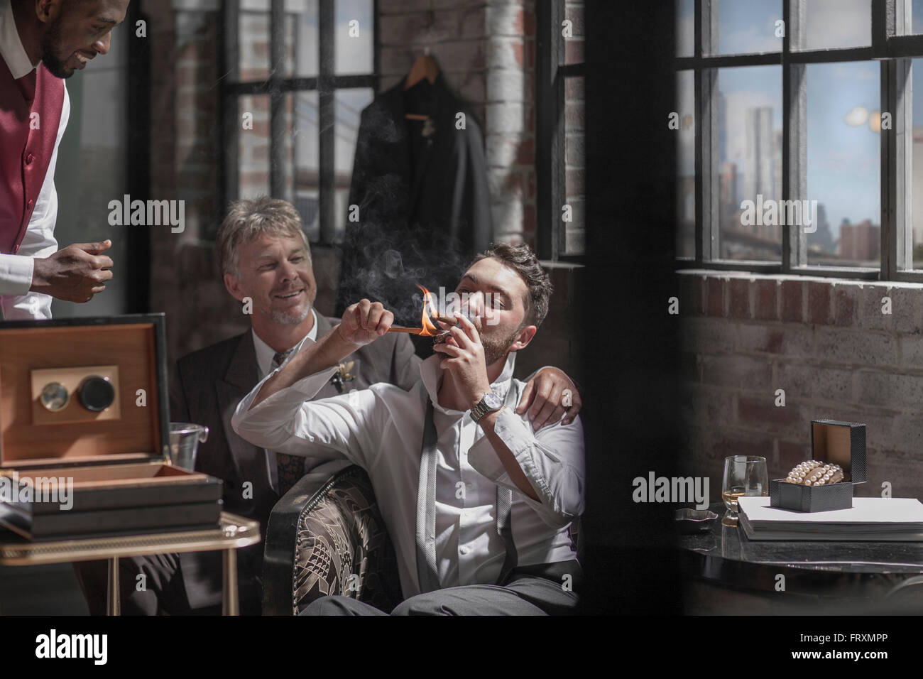Groom with best man smoking a cigar before the wedding Stock Photo - Alamy