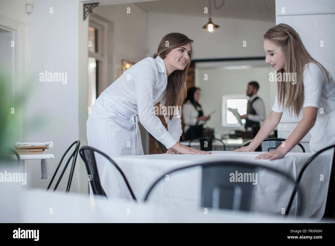 Restaurant staff preparing tables for service Stock Photo - Alamy