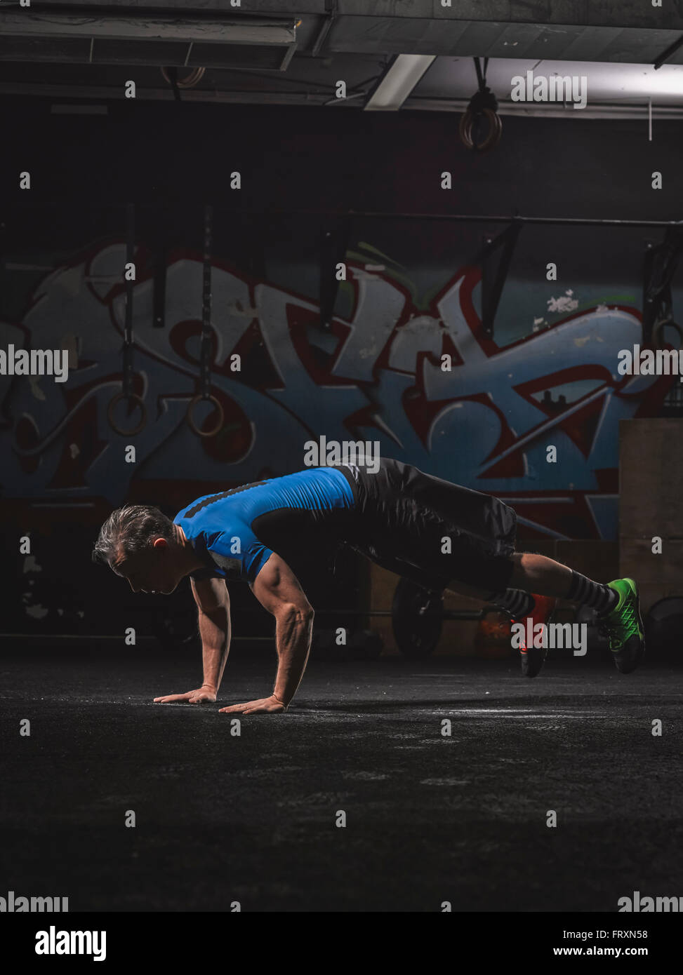 Mature crossfit athlete exercising doing burpees Stock Photo - Alamy