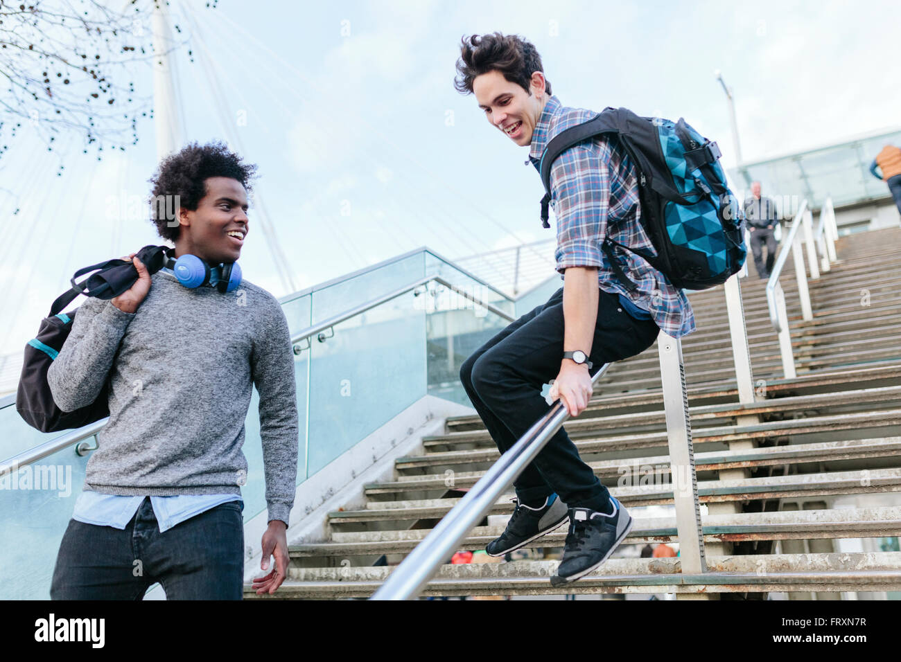 Young man sliding on a stair-rail Stock Photo - Alamy