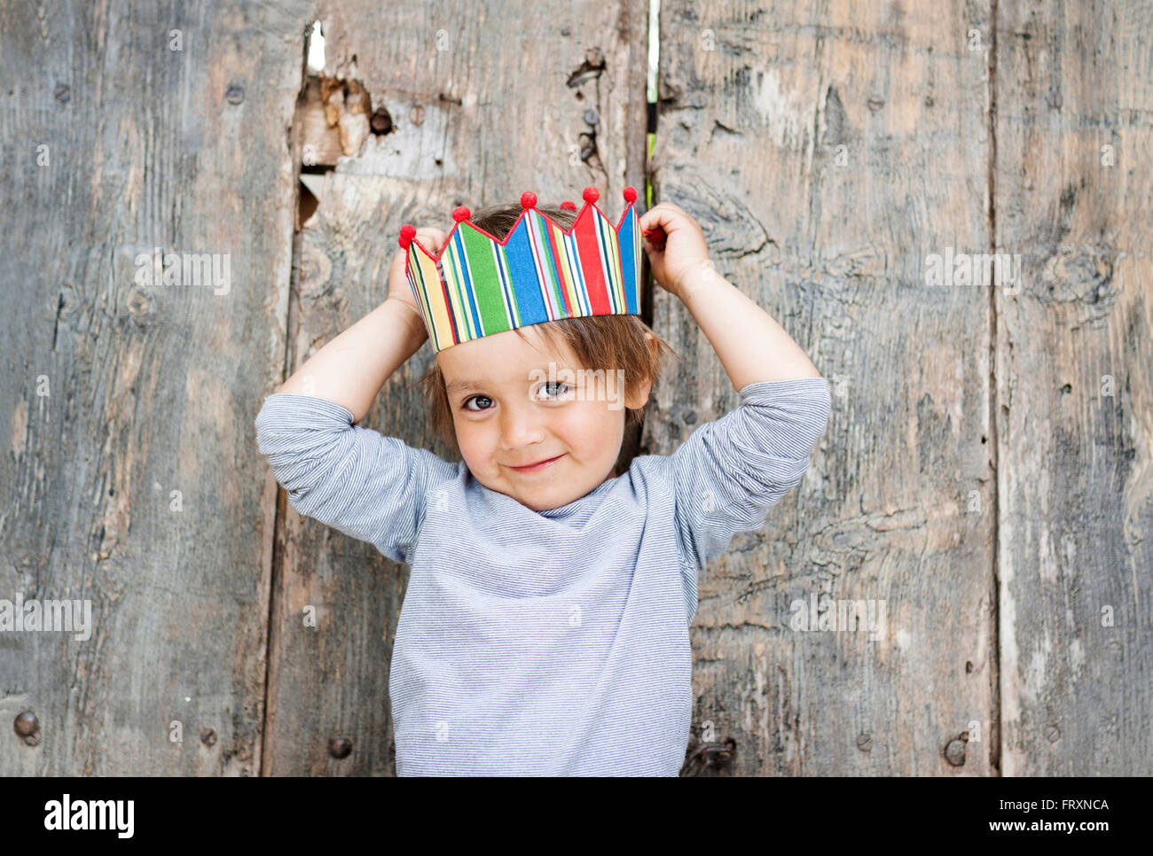 Portrait of smiling little boy wearing paper crown Stock Photo - Alamy