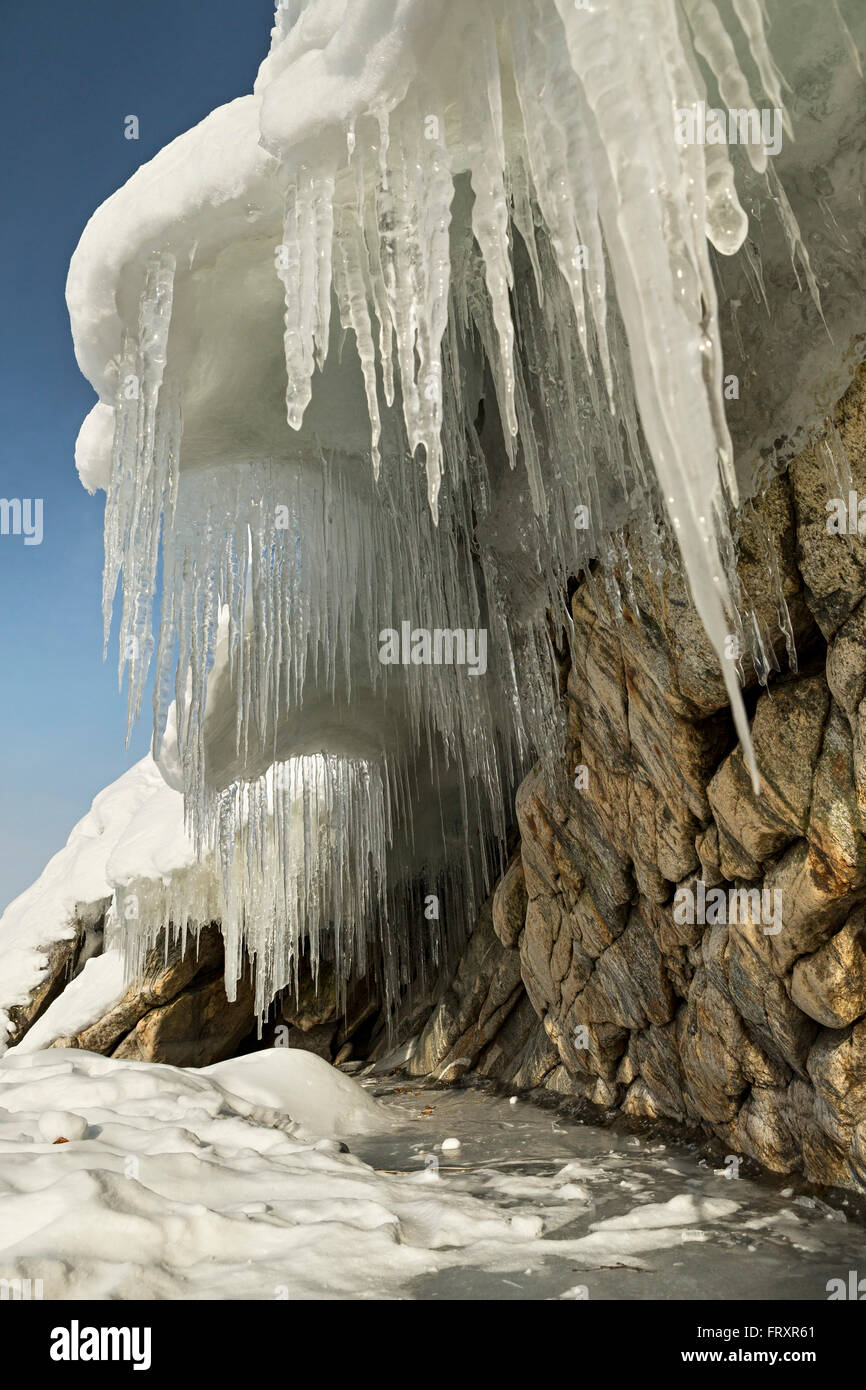 Huge icicles on rocks Stock Photo - Alamy