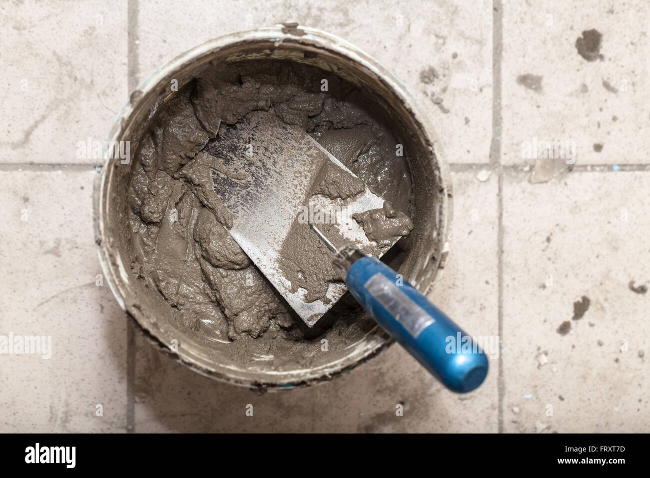 bucket with cement and trowel on tiles Stock Photo - Alamy