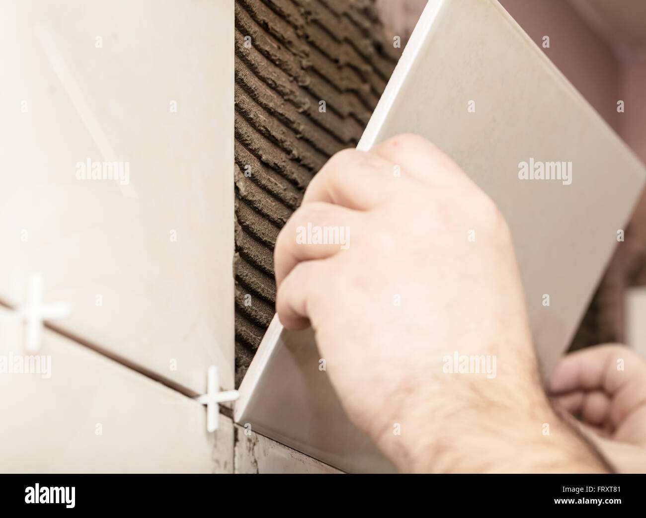 Worker laying tiles on wall hi-res stock photography and images - Alamy
