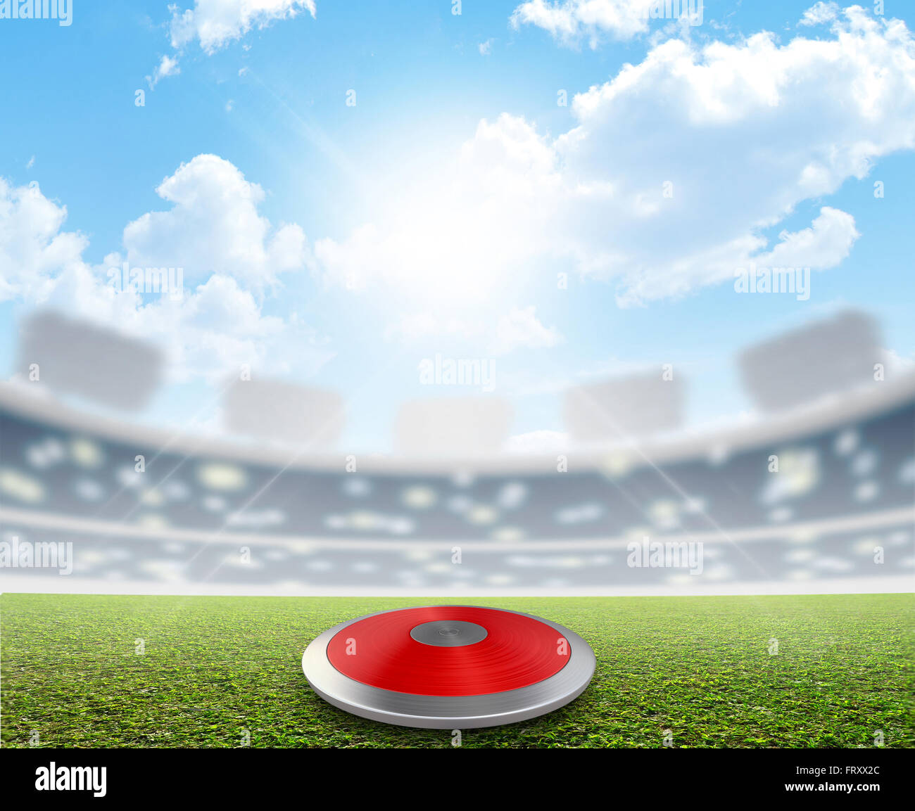 A discus in a generic sports stadium resting on a marked green grass ...