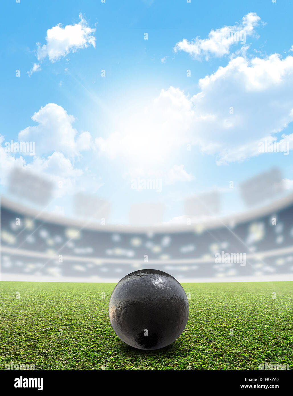 A shot put ball in a generic sports stadium resting on a marked green ...
