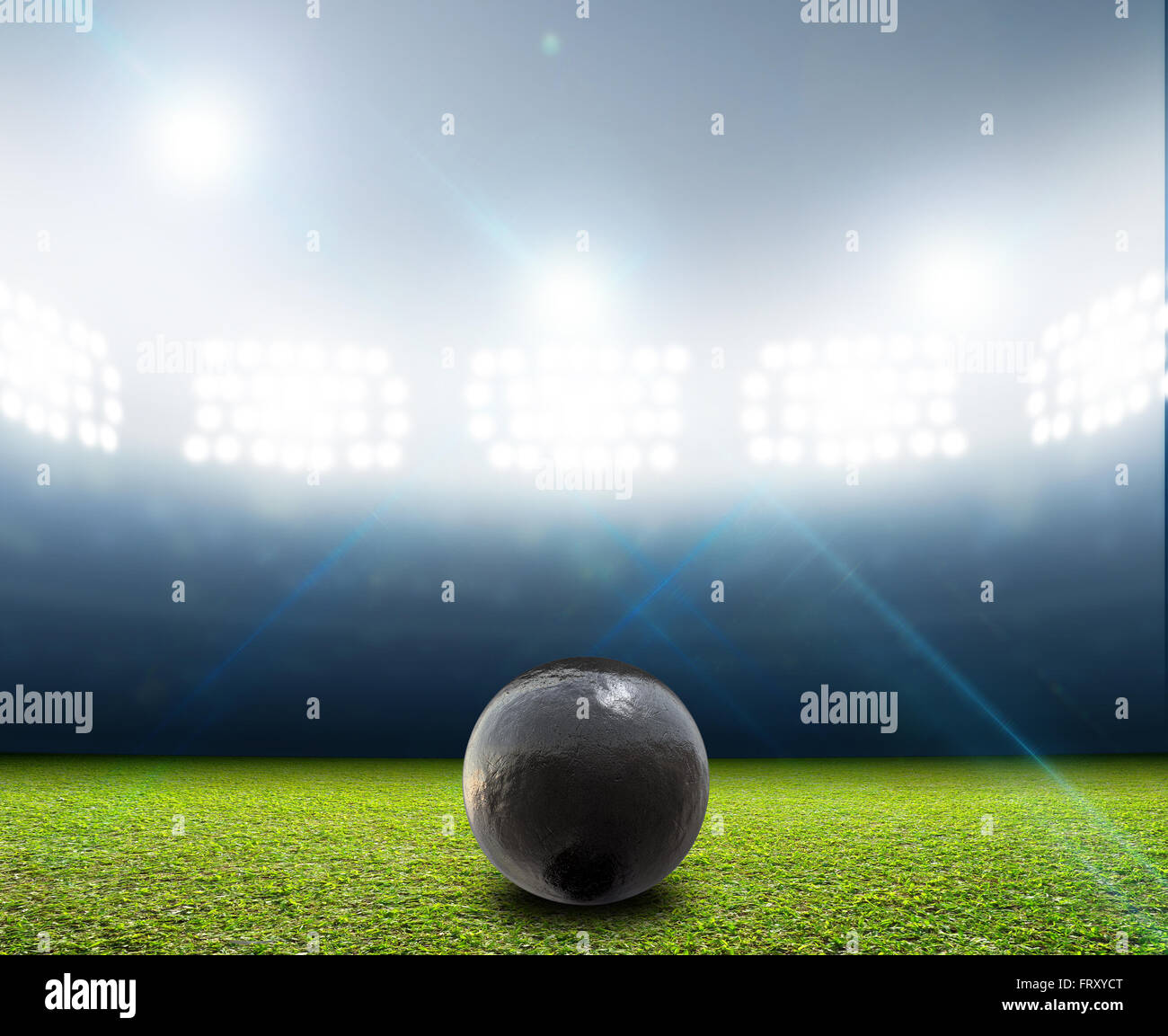A shot put ball in a generic stadium resting on an unmarked green grass ...