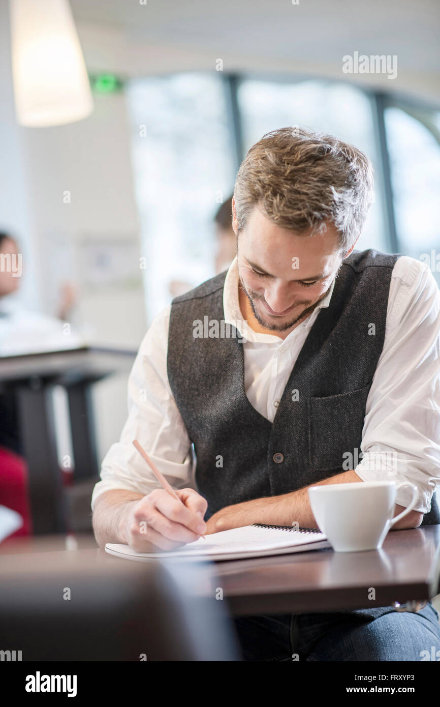 creative man writing in a cafe Stock Photo - Alamy